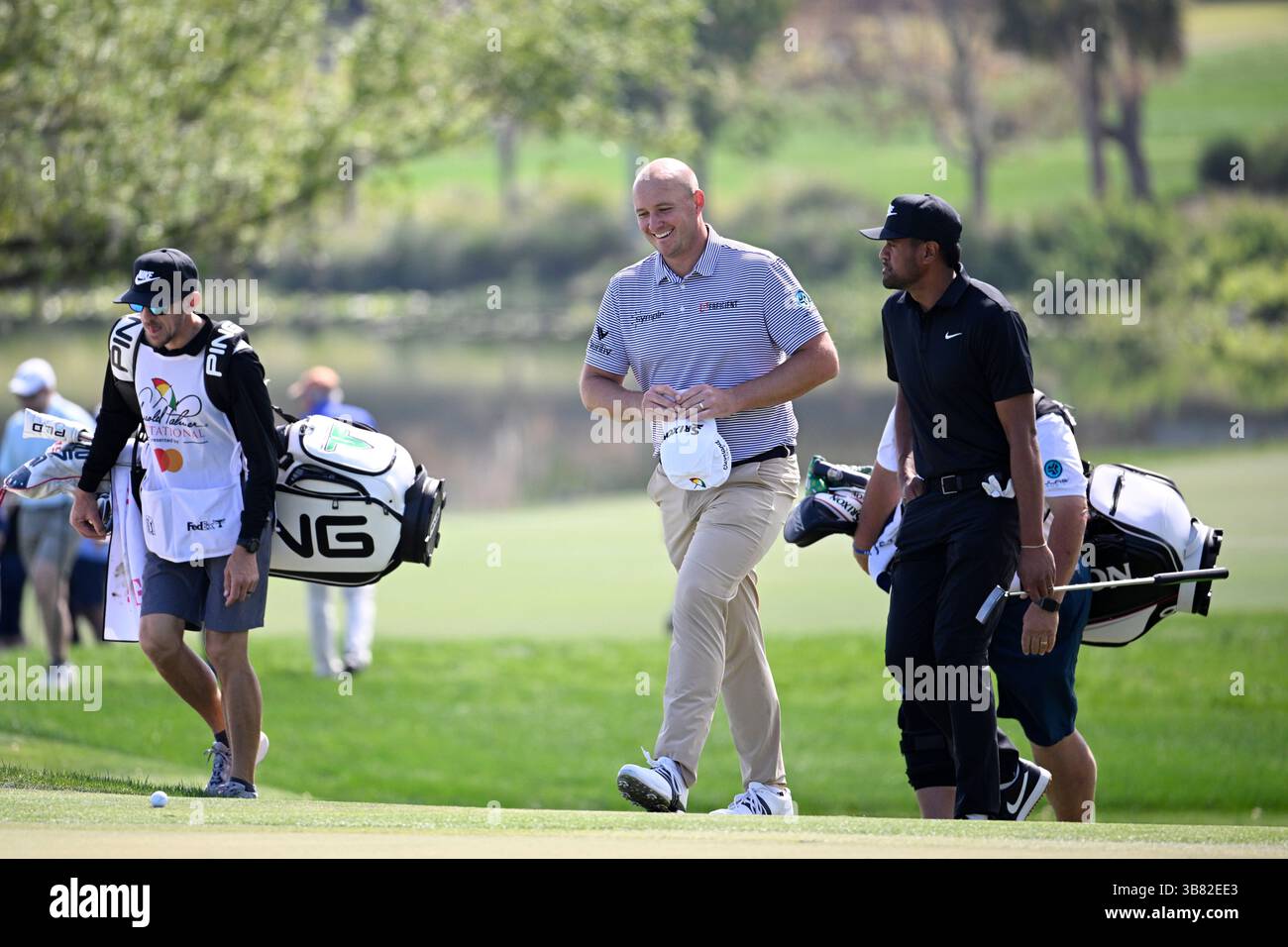 Sepp Straka, center, of Austria, and Tony Finau, right, walk onto the ...