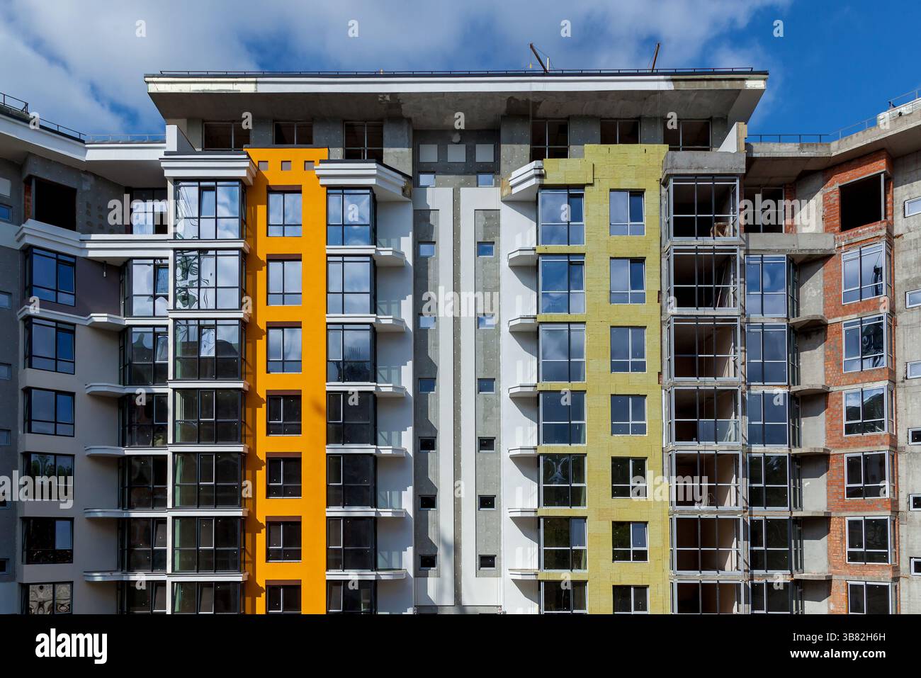 Contemporary multi-story residential complex in various stages of ...