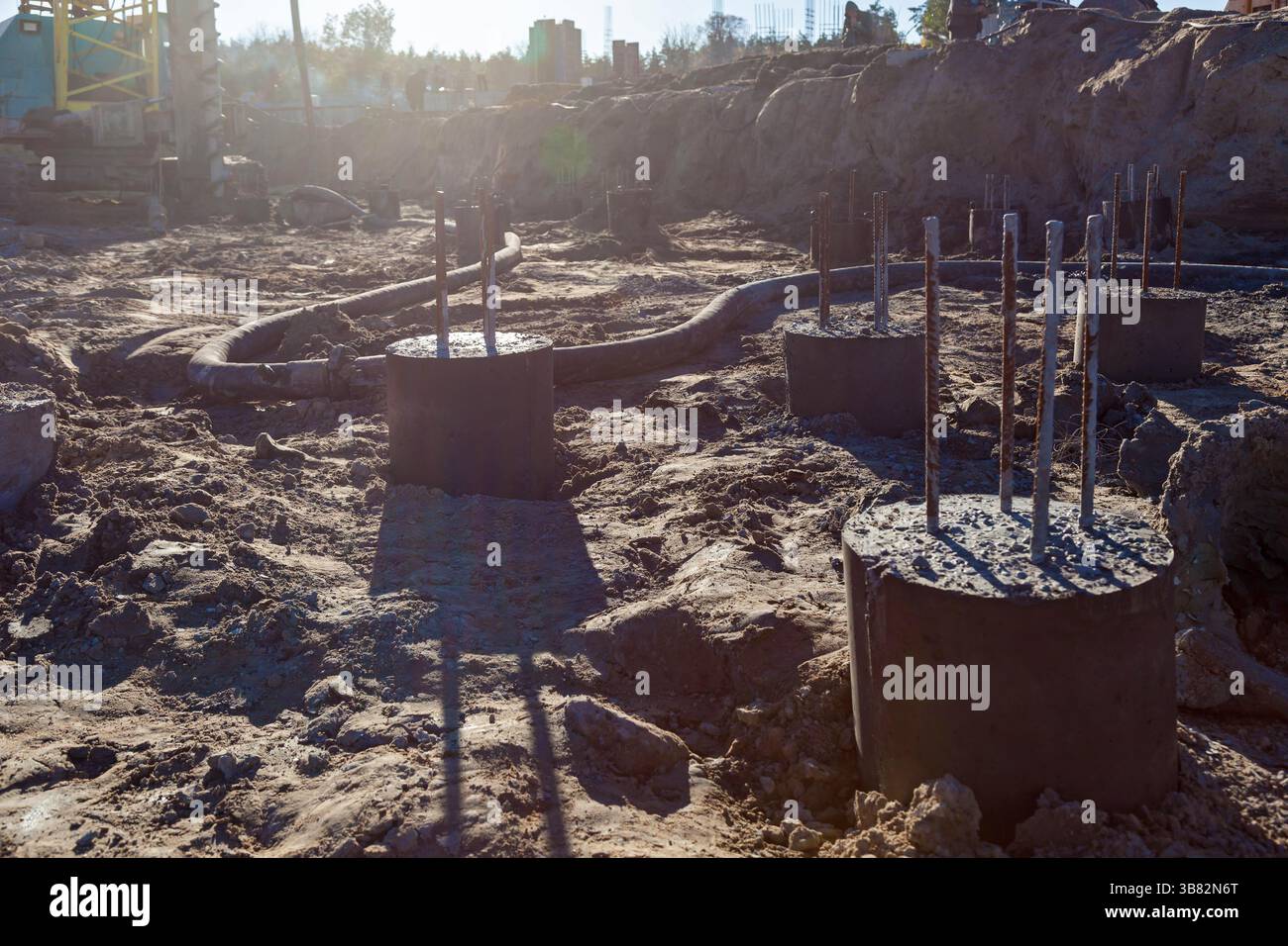 Exposed cylindrical concrete piles with protruding steel reinforcement ...