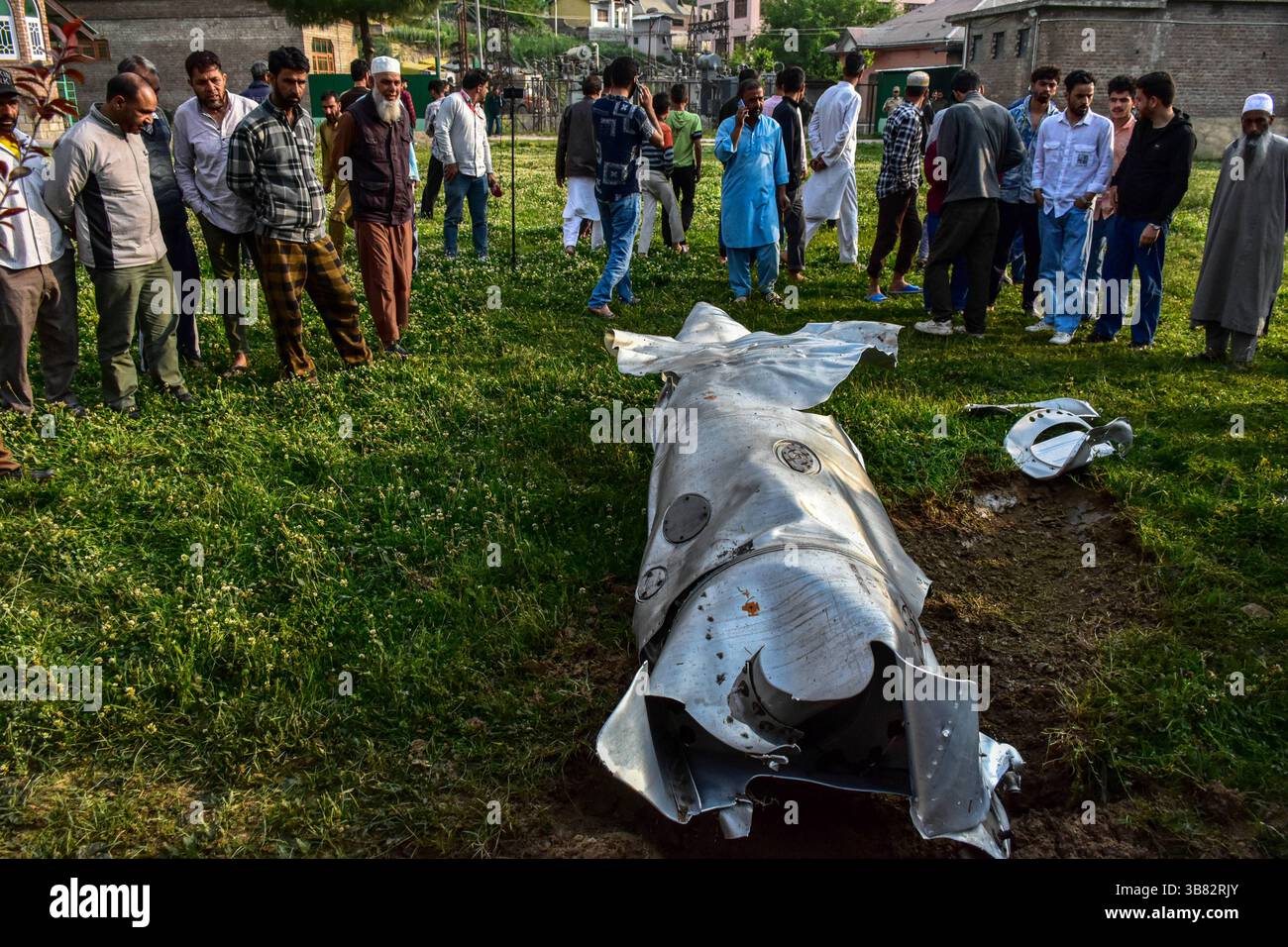 Kashmir, India. 07th May, 2025. Residents gather around the debris of ...
