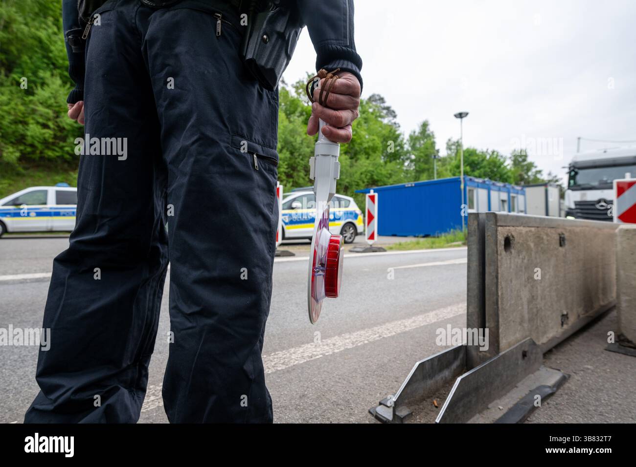 Trier, Germany. 07th May, 2025. A police officer observes passing cars ...