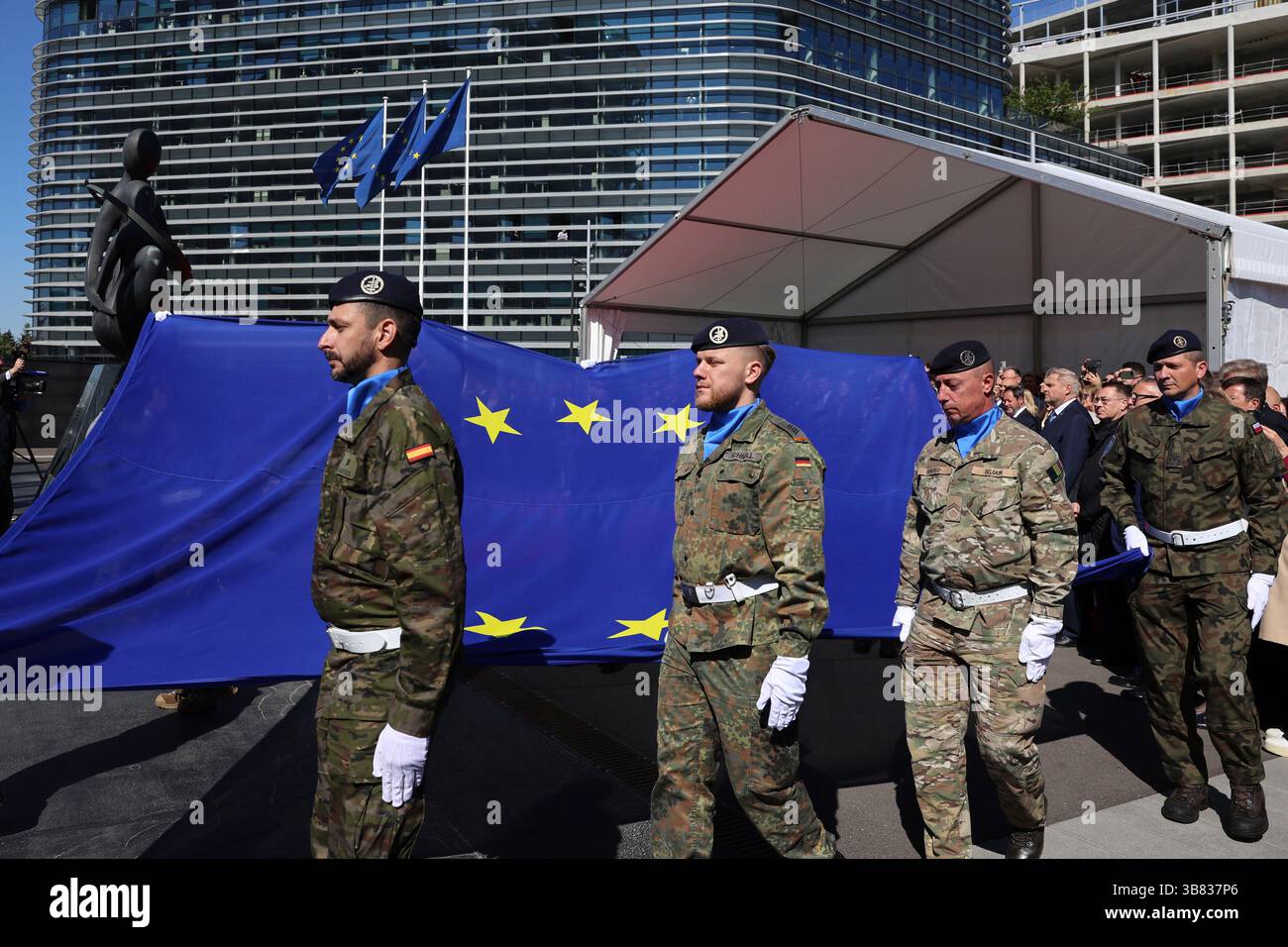 Soldiers display the European flag during a ceremony marking the 80th ...