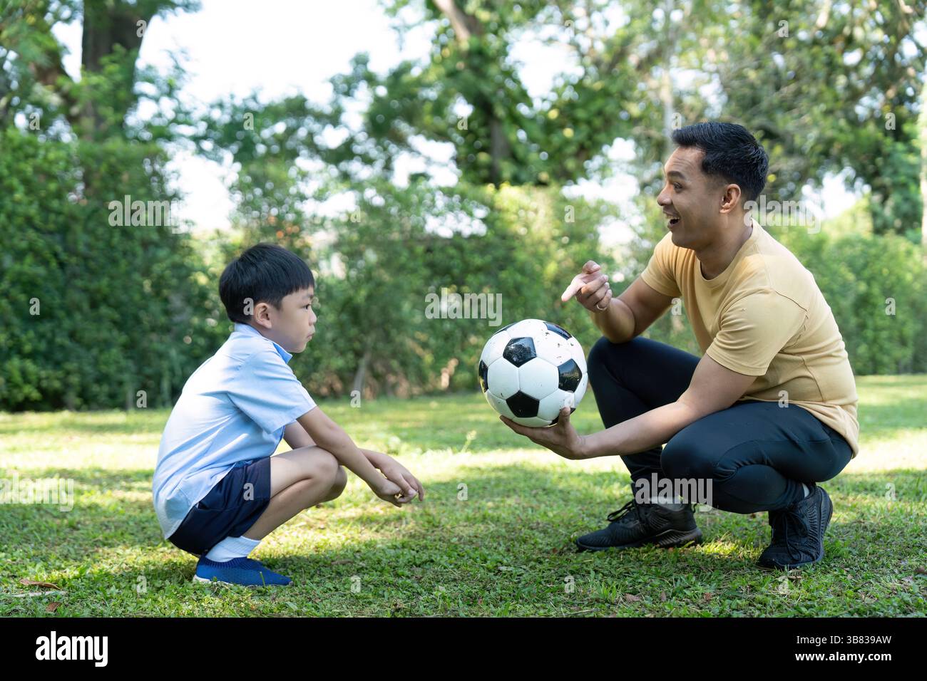 Wellness focus: Father teaching soccer skills to his son Stock Photo ...
