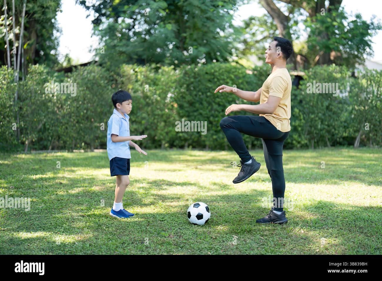 Wellness in Family Interaction: Father and son practicing soccer ...