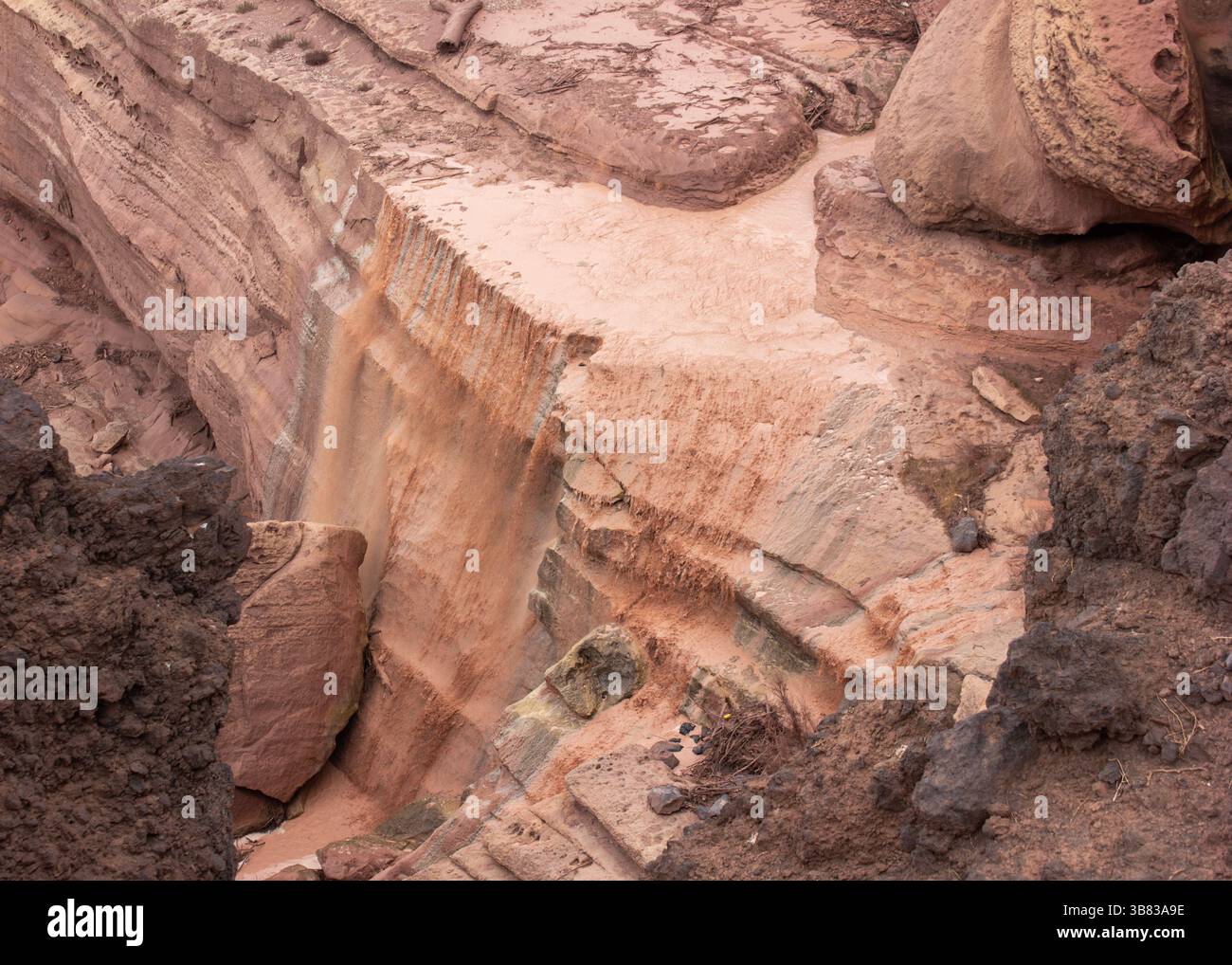 A stunning waterfall flows gracefully over a rugged cliff, surrounded ...