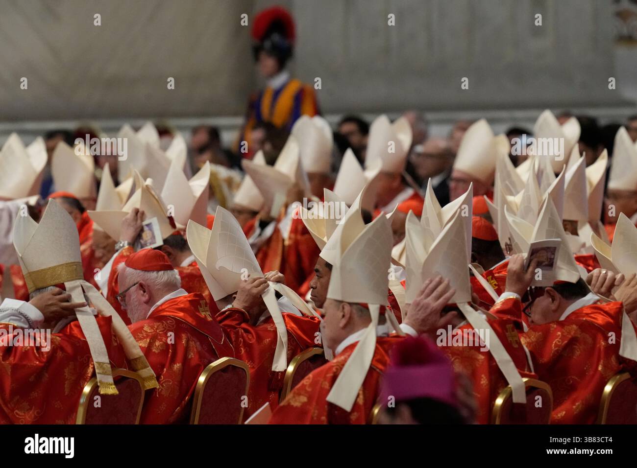 Cardinals adjust their mitre hats during a final Mass celebrated by ...