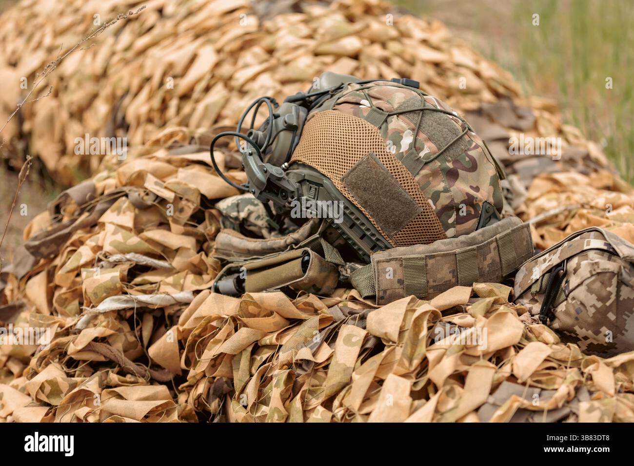 Military helmet lies on camouflage net Stock Photo - Alamy