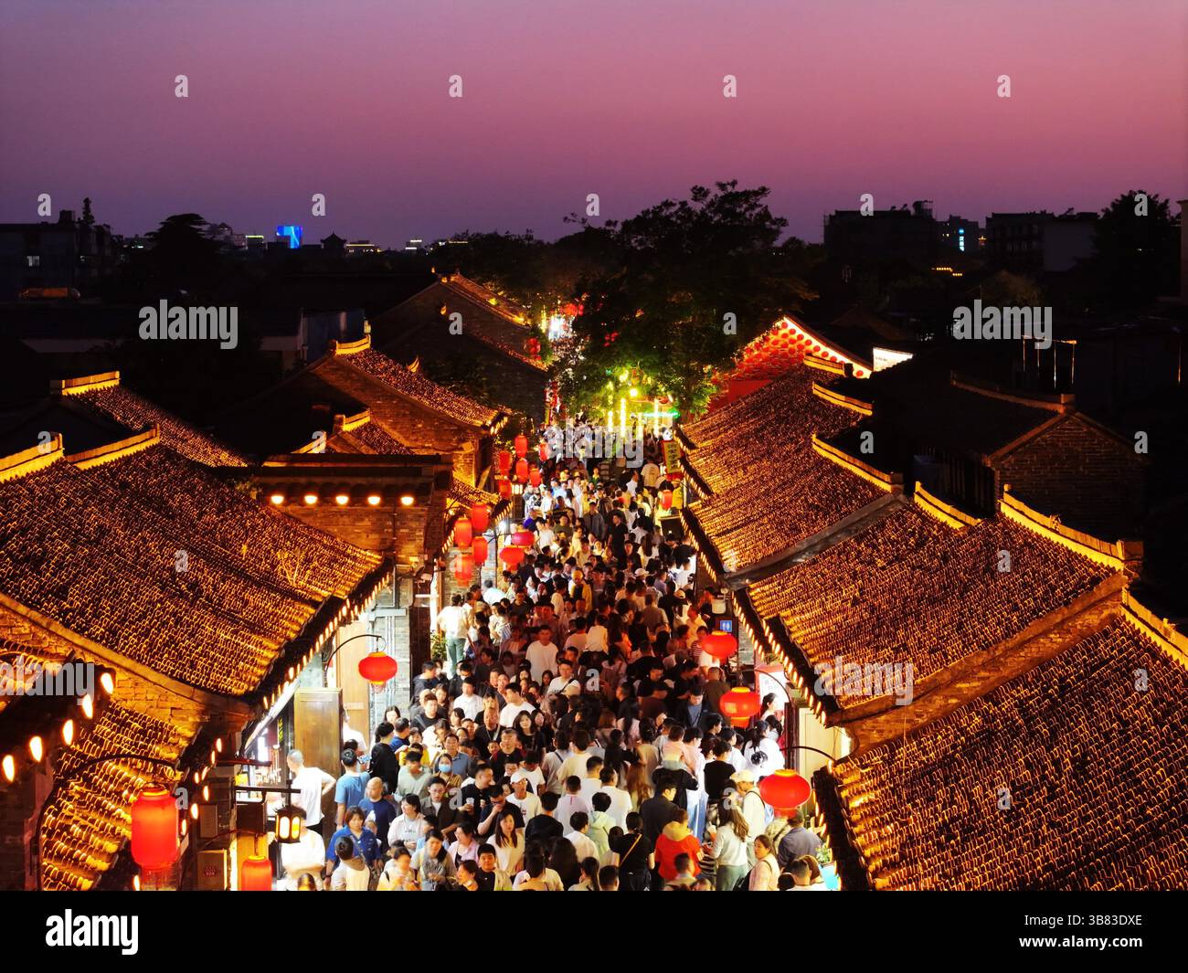 Aerial photo shows tourists visiting the Dongguan Street at night in ...