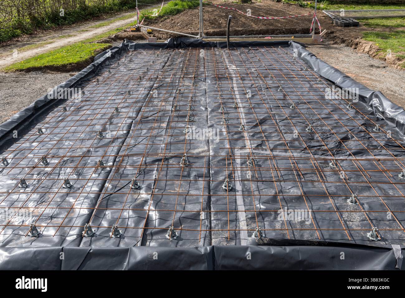 Steel reinforcement grid (rebar grid) fixed over a plastic membrane (DPM) ready for concrete to ...