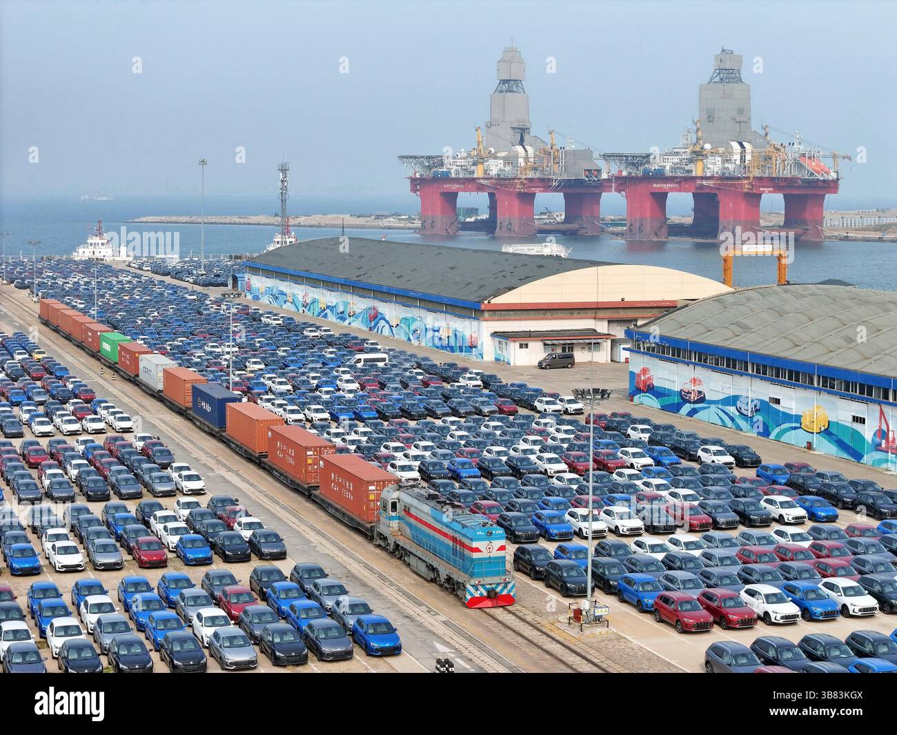 A view of new cars and two semi-submersible offshore drilling platforms ...