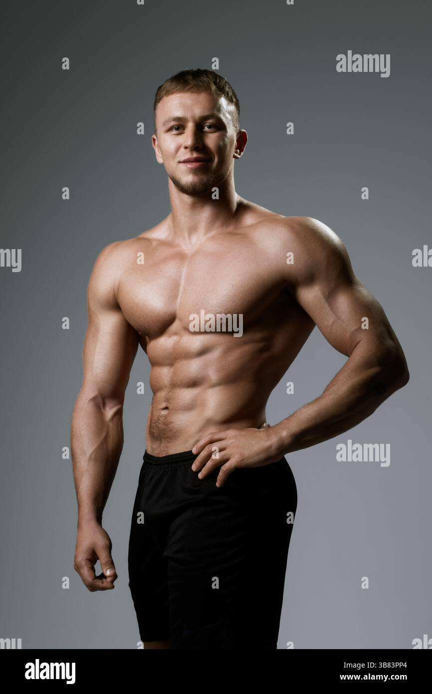 A fit male model showcases his strength in a captivating pose under ...