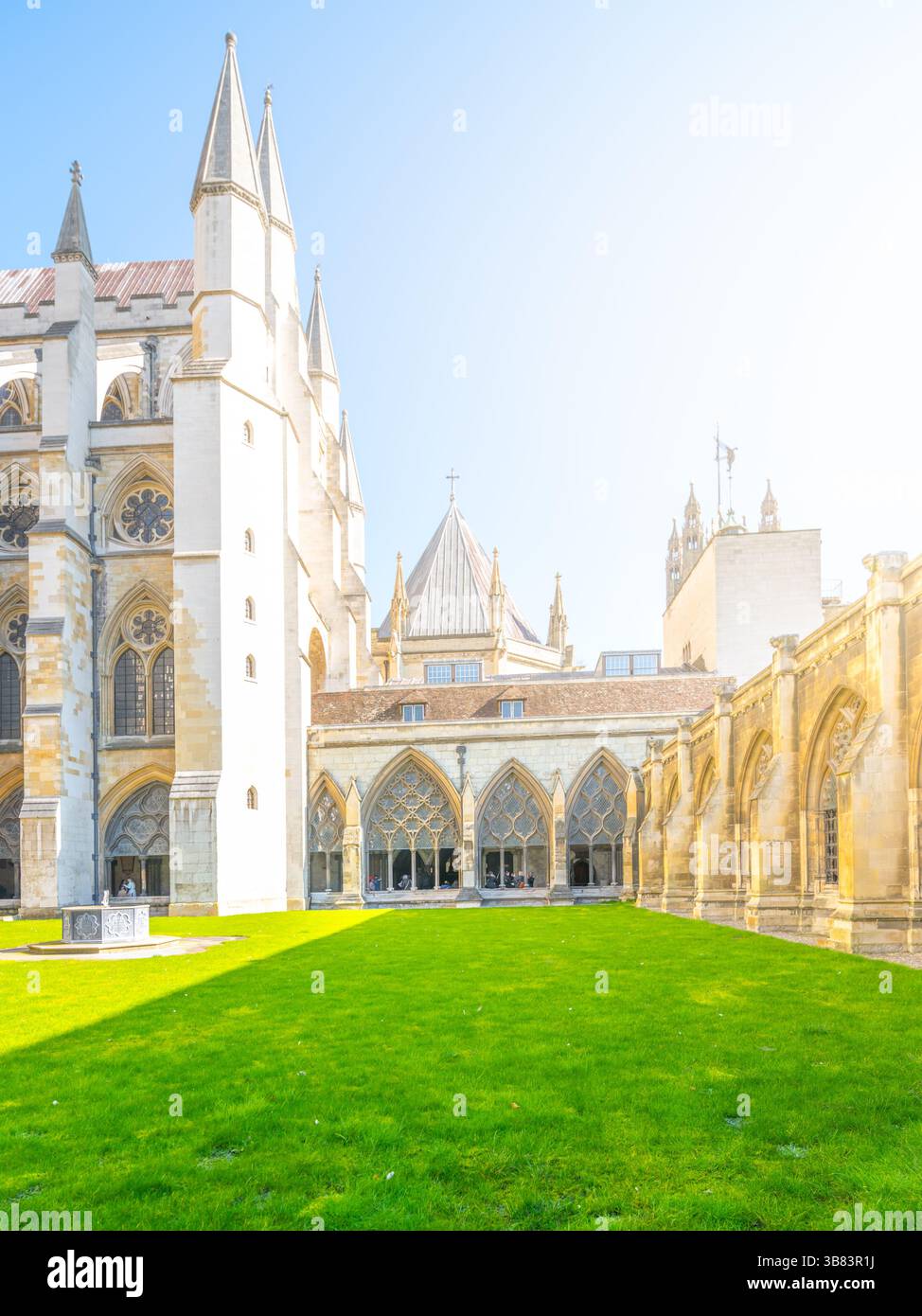 Visitors enjoy the serene green lawn at Westminster Abbey's cloisters ...
