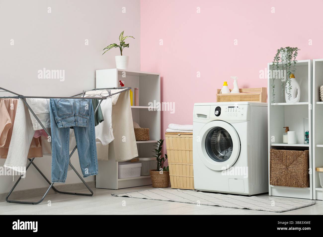 Interior of modern laundry room with washing machine, dryer and ...
