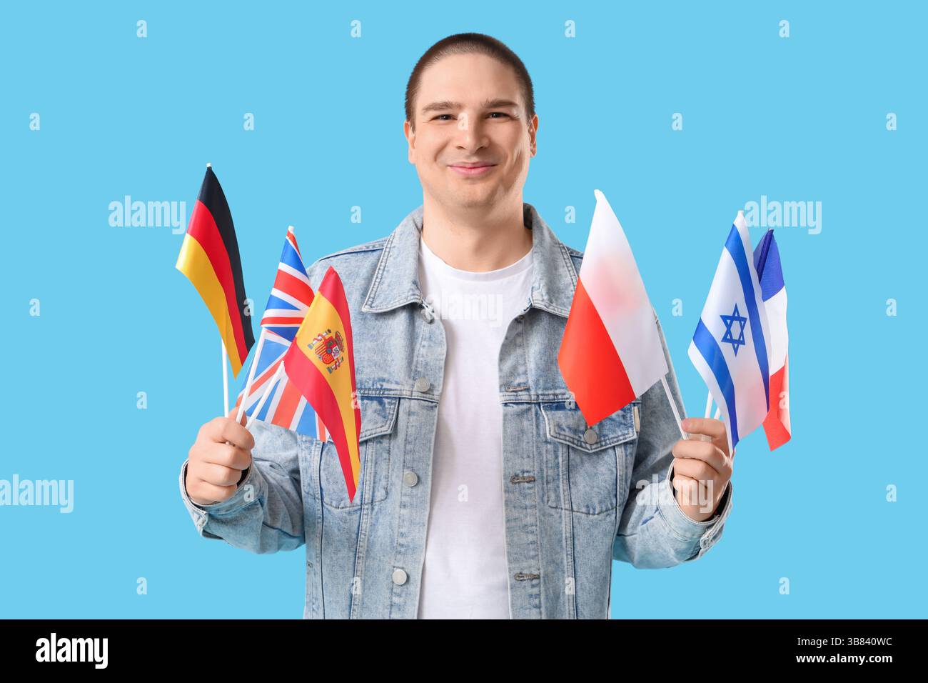 Young man with flags of different countries on color background Stock ...