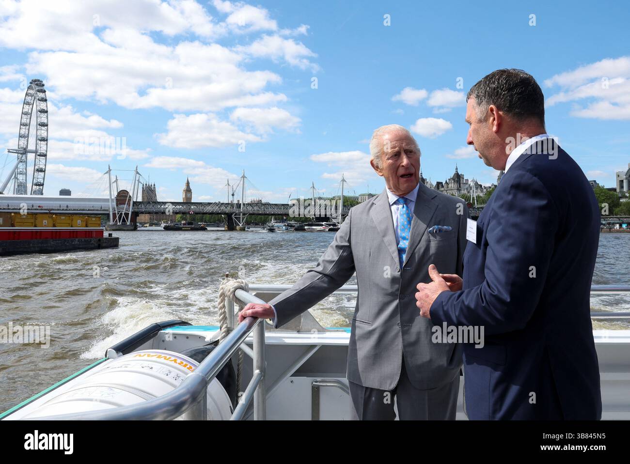 King Charles III speaks with Sean Collins (right), Chief Executive ...