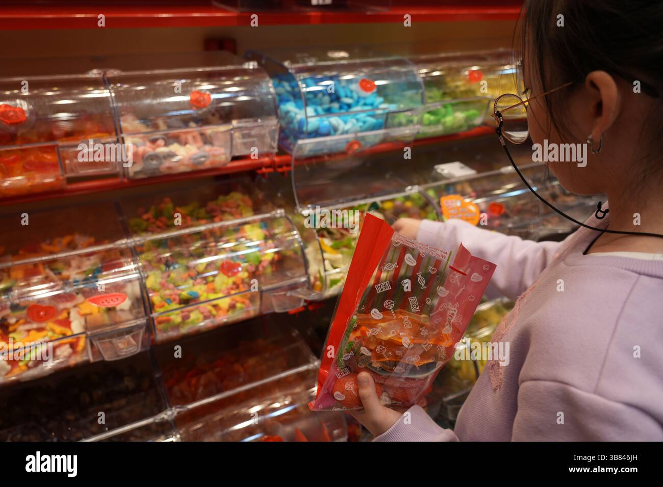 Girl puts sweets in hi-res stock photography and images - Alamy