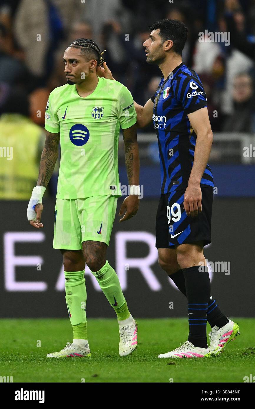 Raphinha of F.C. Barcelona and Mehdi Taremi of F.C. Inter at the end of ...