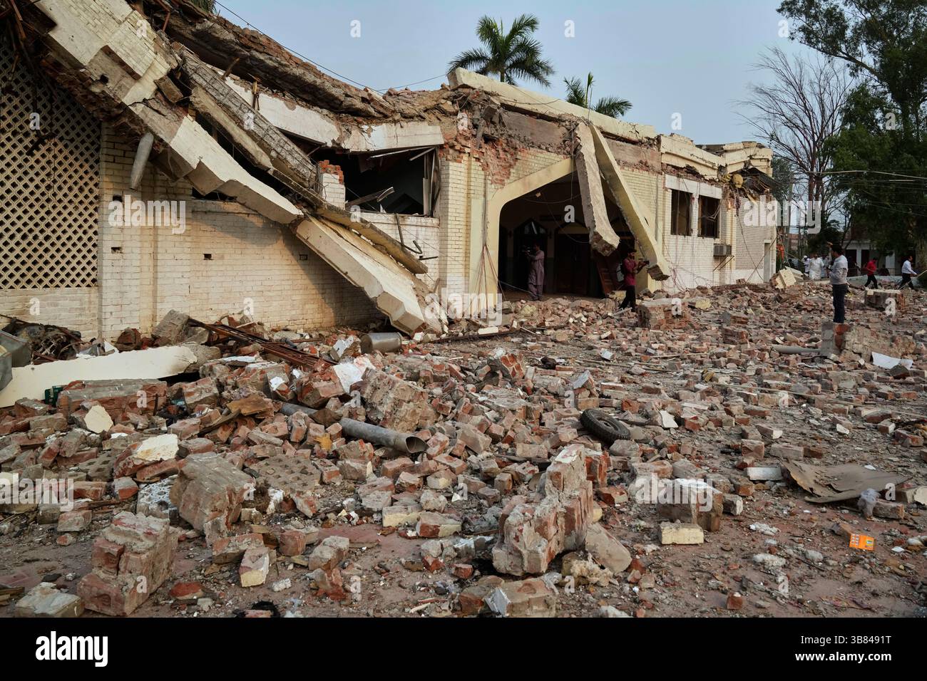 Members of media photograph the rubble of a mosque building damaged by ...