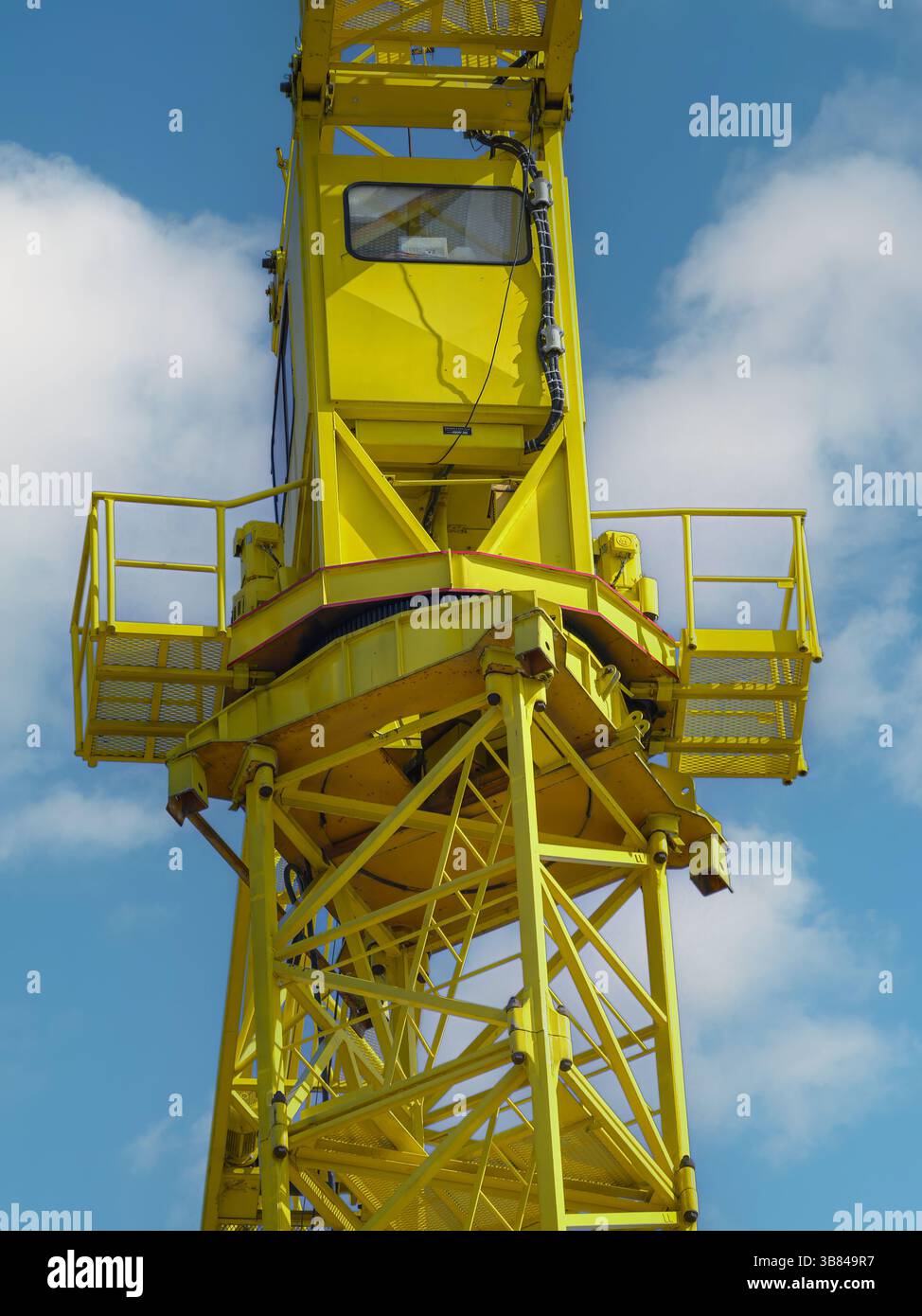 Bright yellow construction crane structure displayed prominently in an ...
