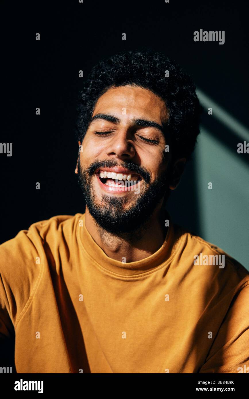 Happy man laughing with eyes closed Stock Photo - Alamy