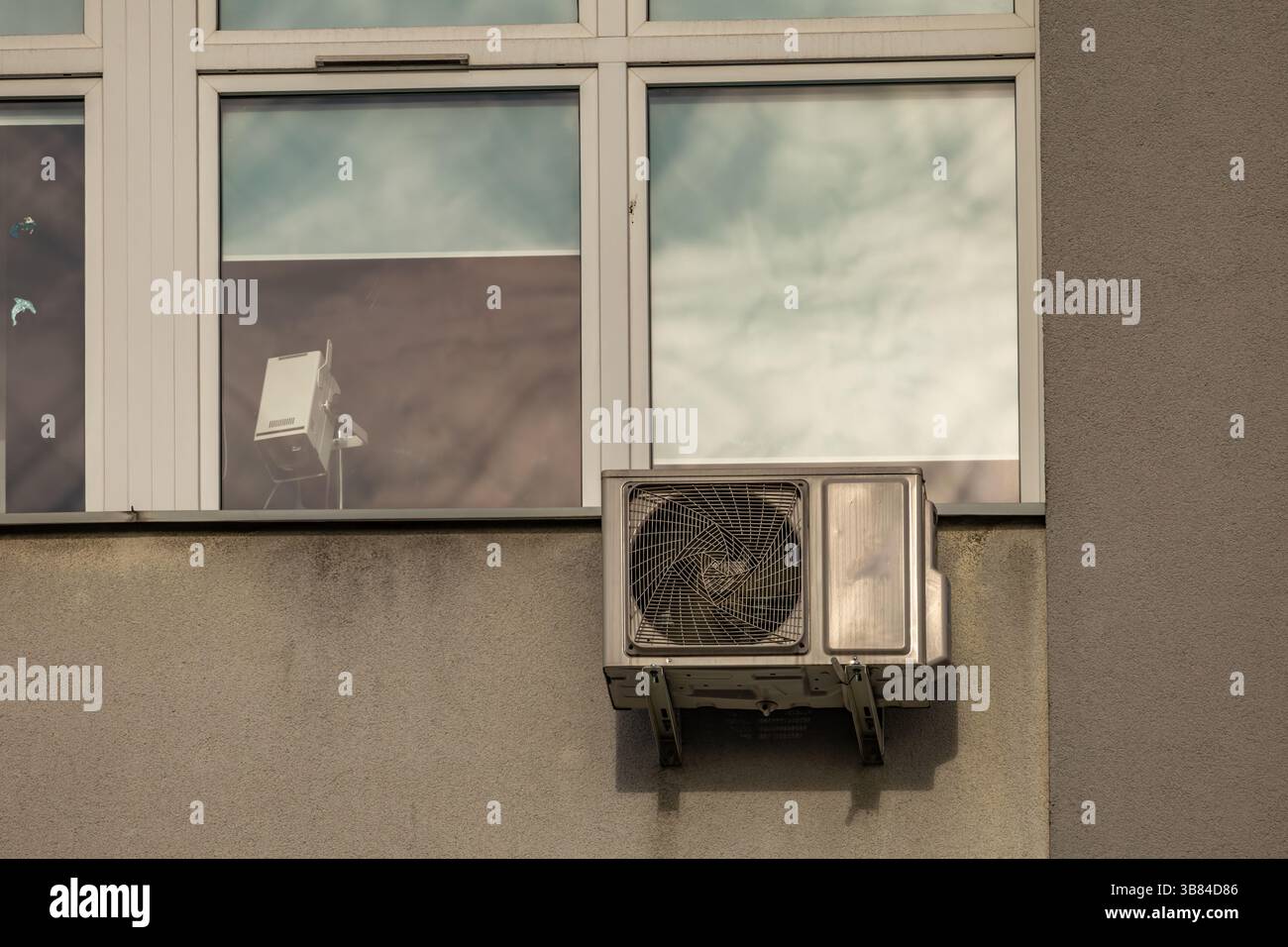 Air conditioner installed on the building facade, heat wave, air ...