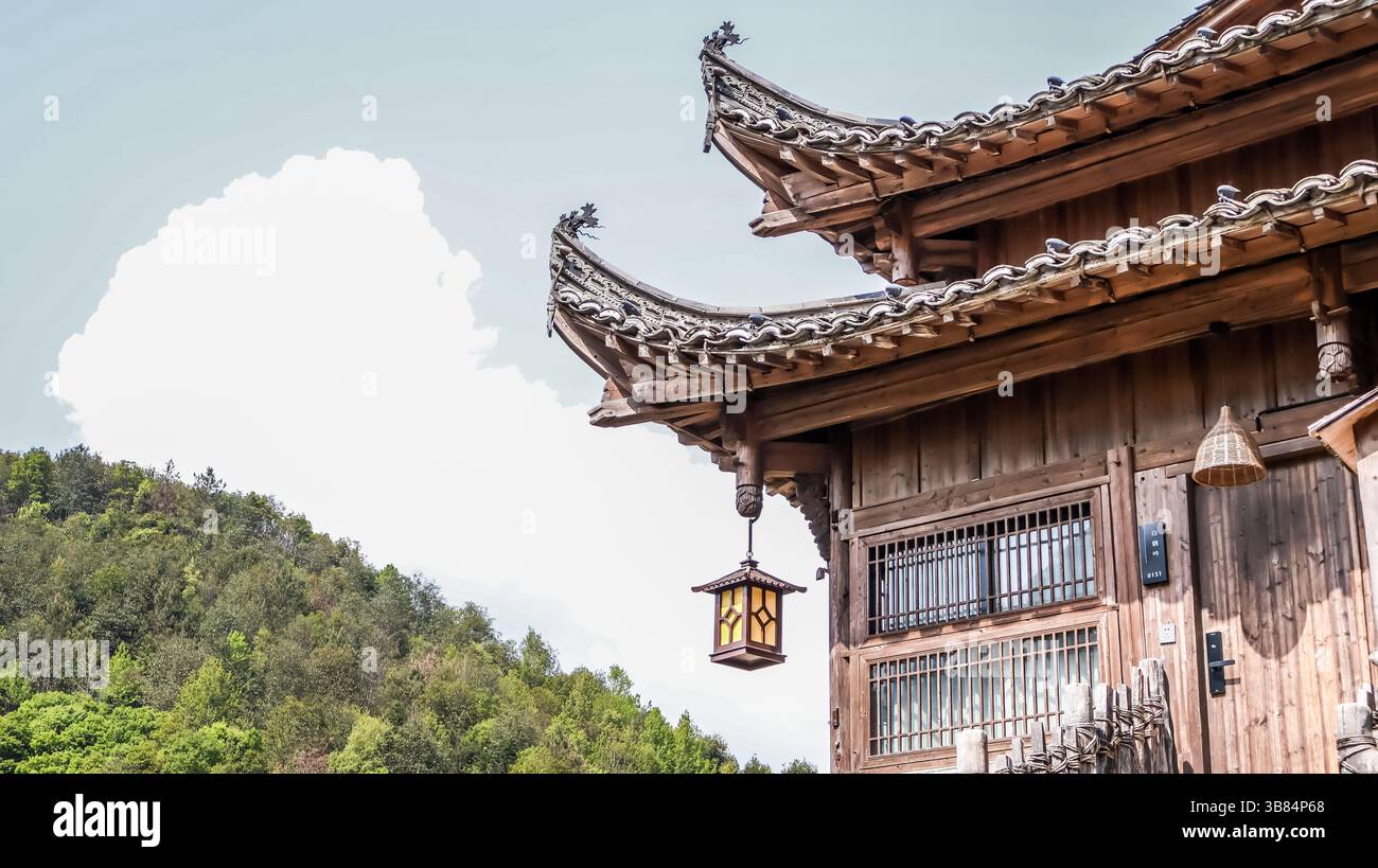 Traditional Chinese wooden architecture with curved roof eaves and ...