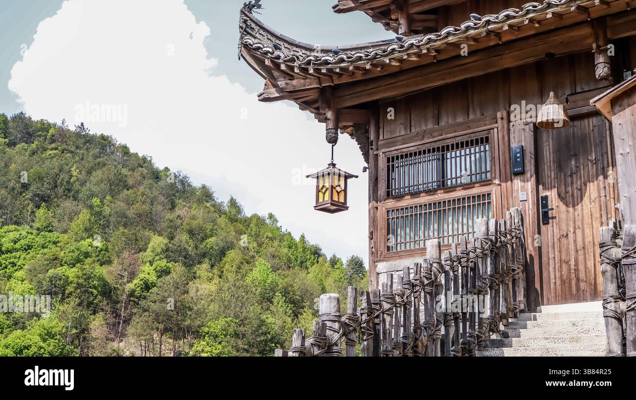 Traditional Chinese wooden architecture with curved roof eaves and ...