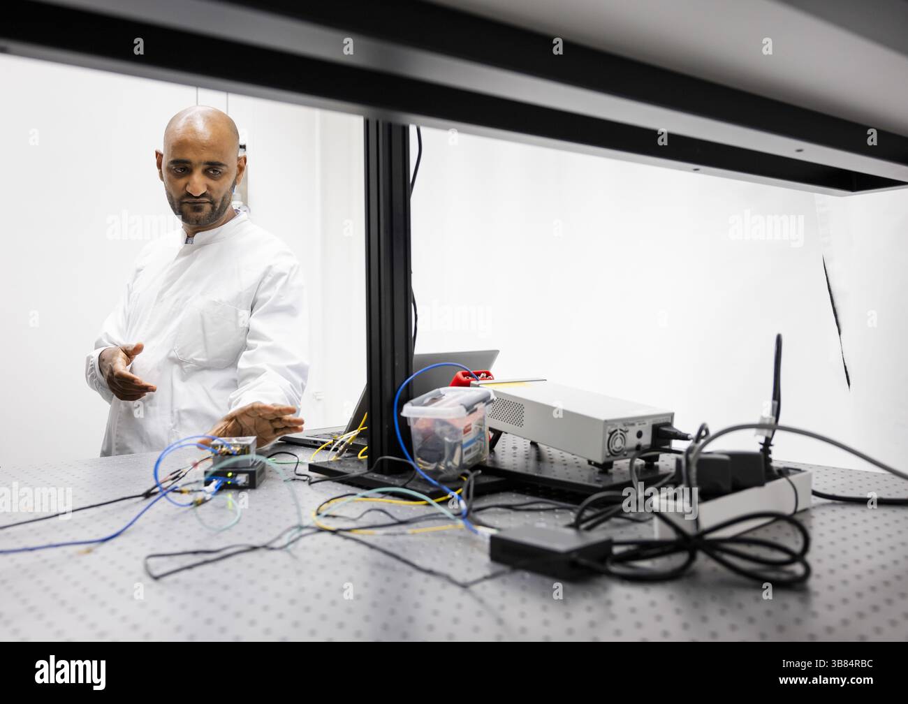 EINDHOVEN - An employee demonstrates work on photonic chips during a ...