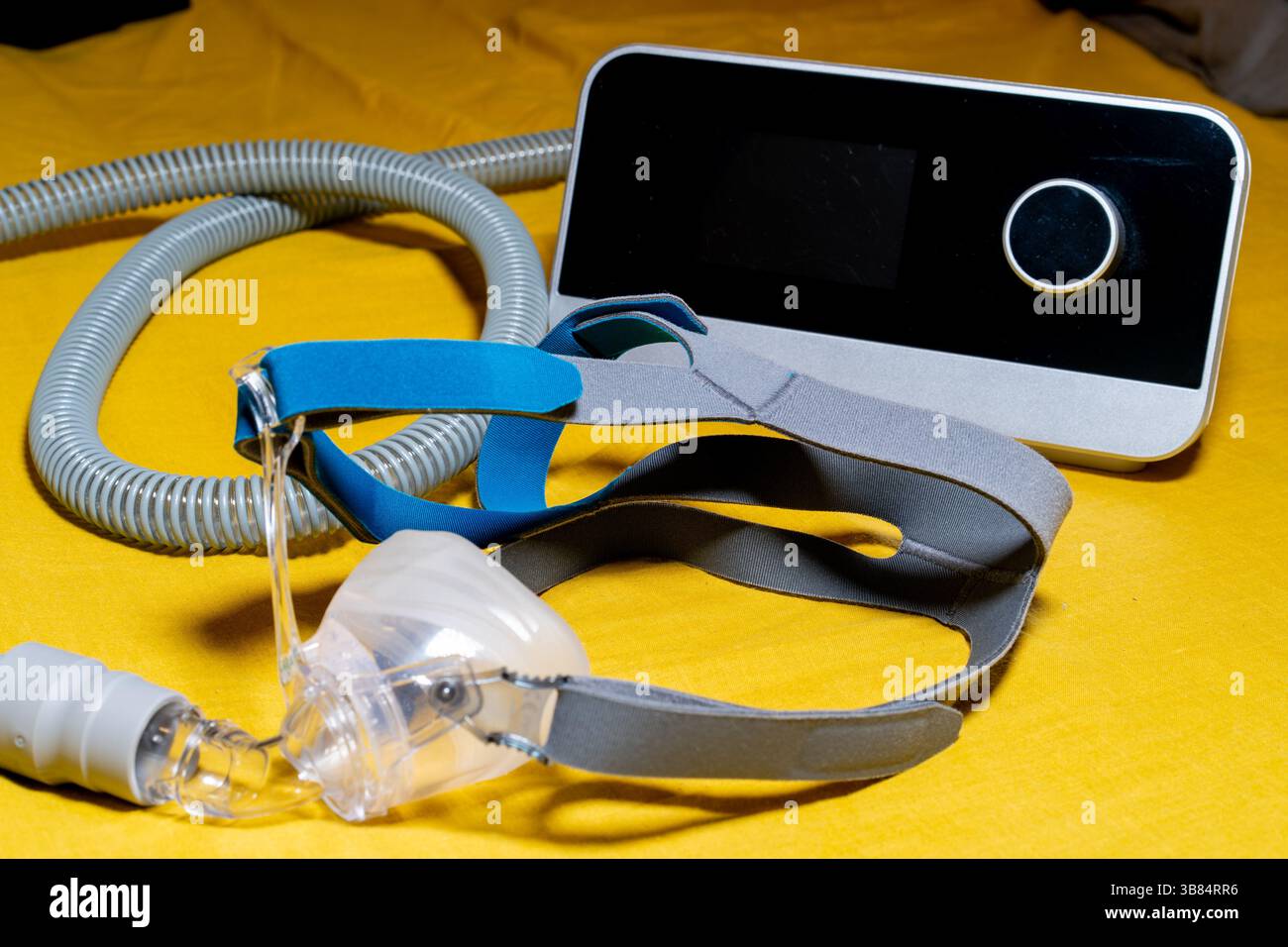 Tube and mask of the Obstructive Sleep Apnea CPAP Machine on a yellow ...