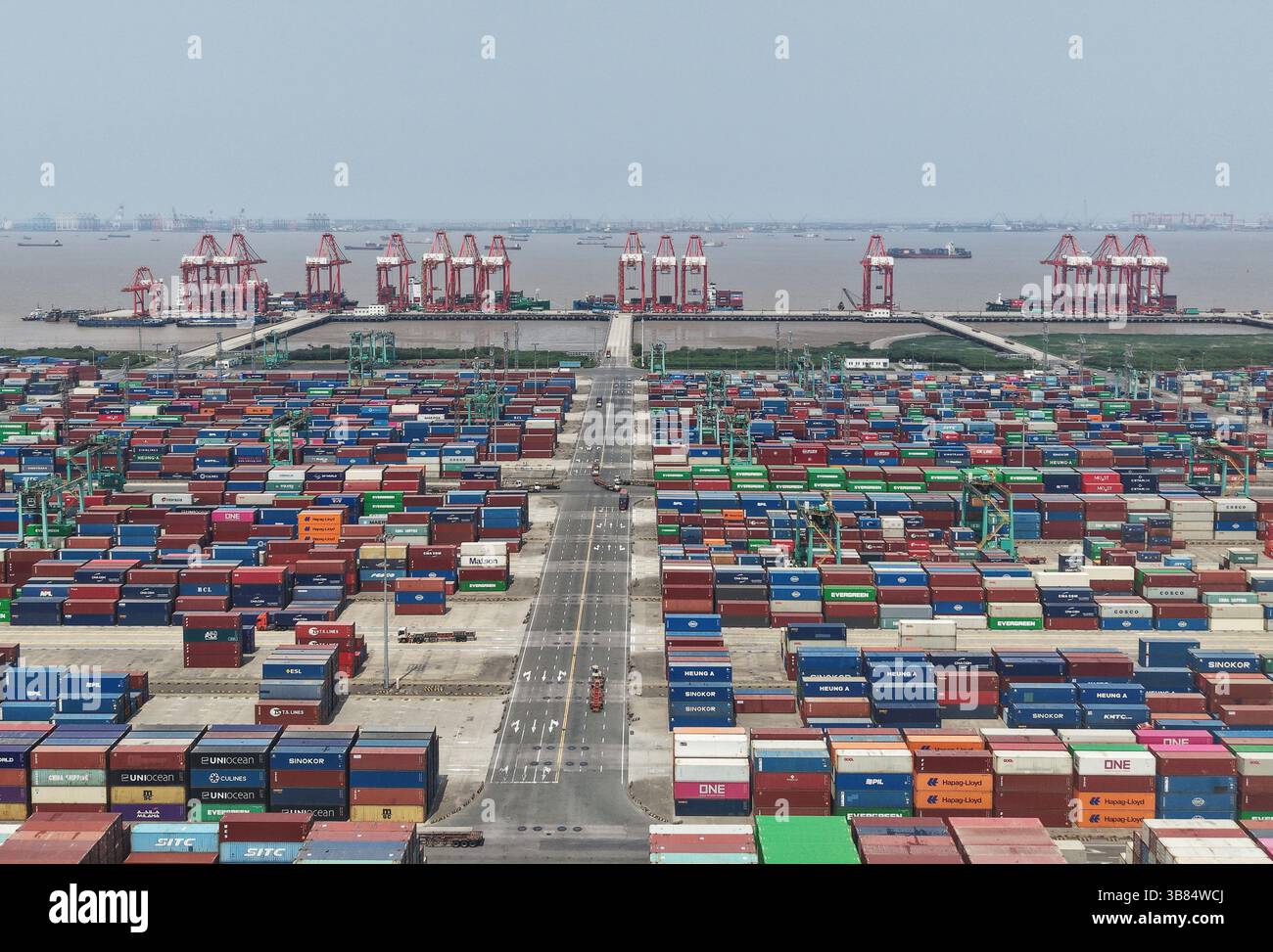 Shanghai, China. 07th May, 2025. Trucks loaded with containers shuttle ...