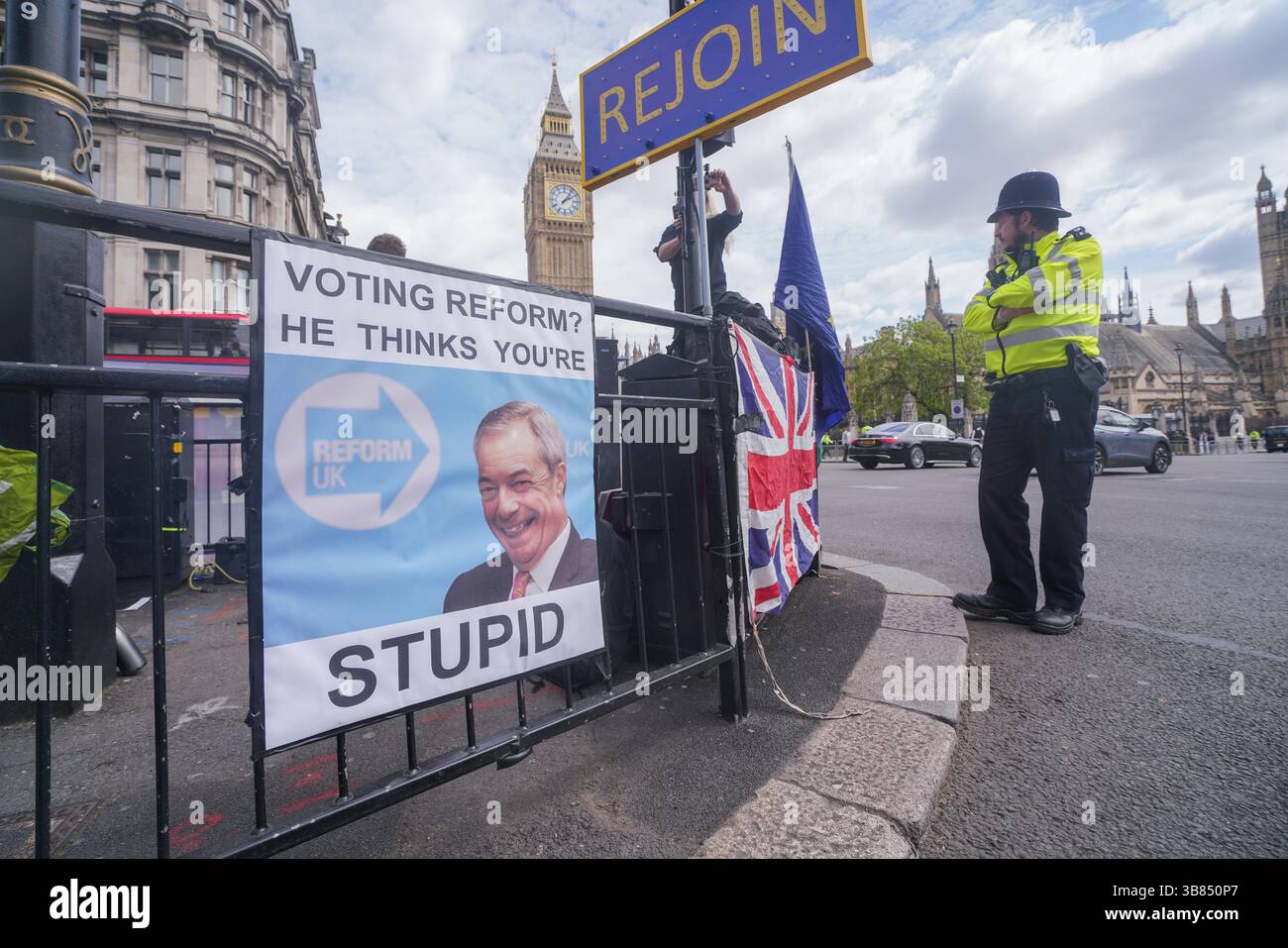 London UK 7 May 2025. A policeman stands next to a picture of Reform UK ...