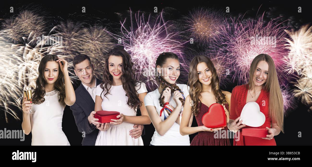 Happy group of festive people over fireworks background Stock Photo - Alamy