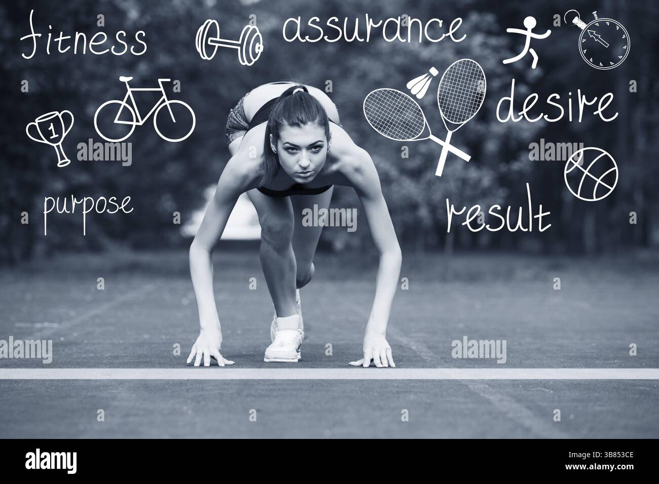 Fitness female runner in ready start line pose outdoors in summer ...