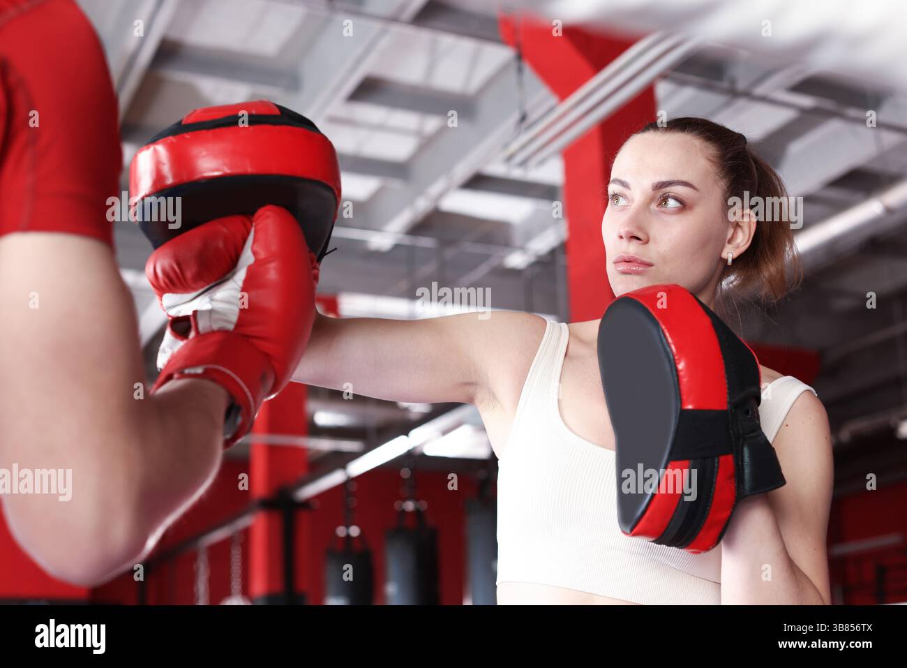 Boxing coach training man in sport center Stock Photo - Alamy