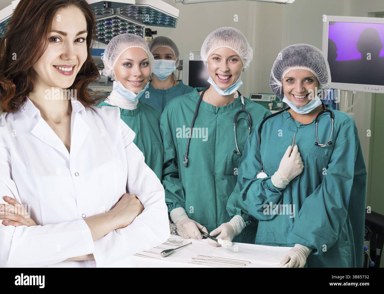 Young doctor woman in white robe stands on the surgeon team background ...