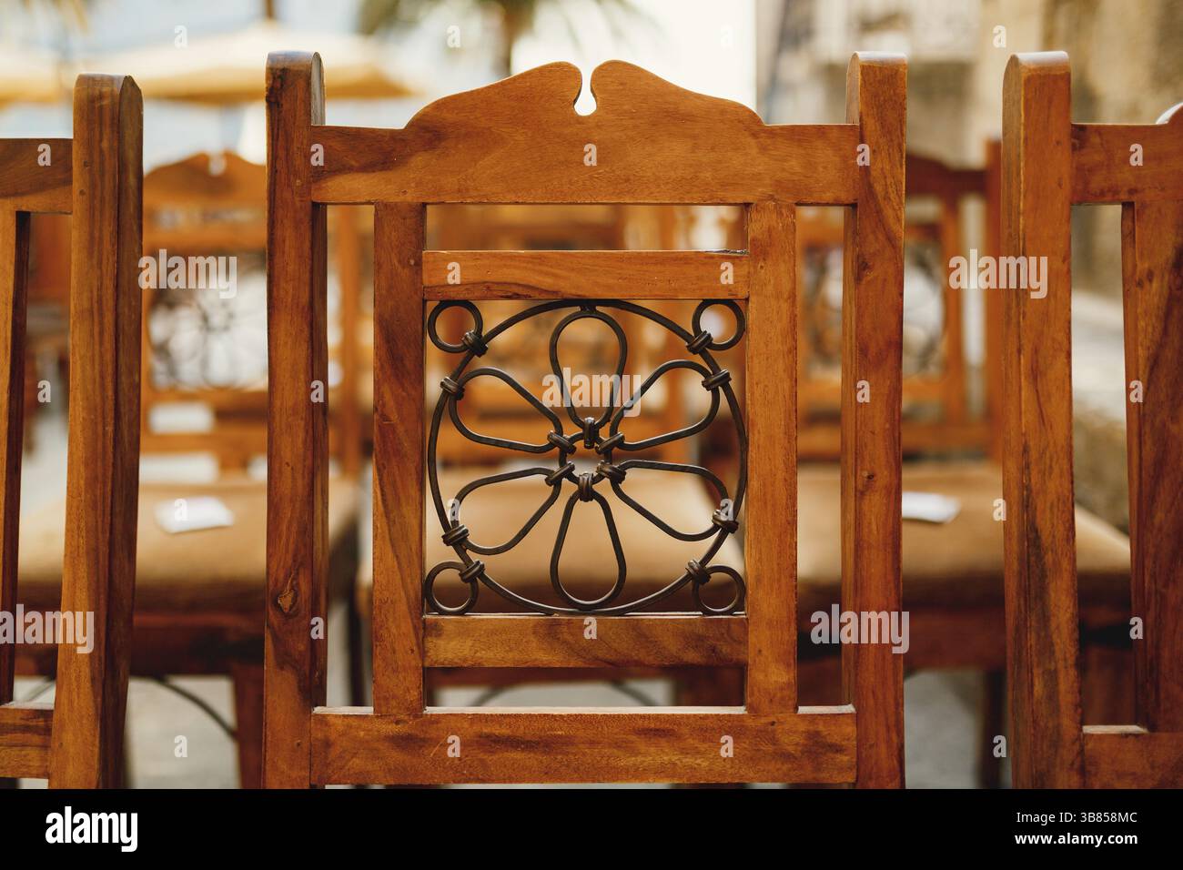 Forged pattern on the back of a wooden chair. Close-up Stock Photo - Alamy