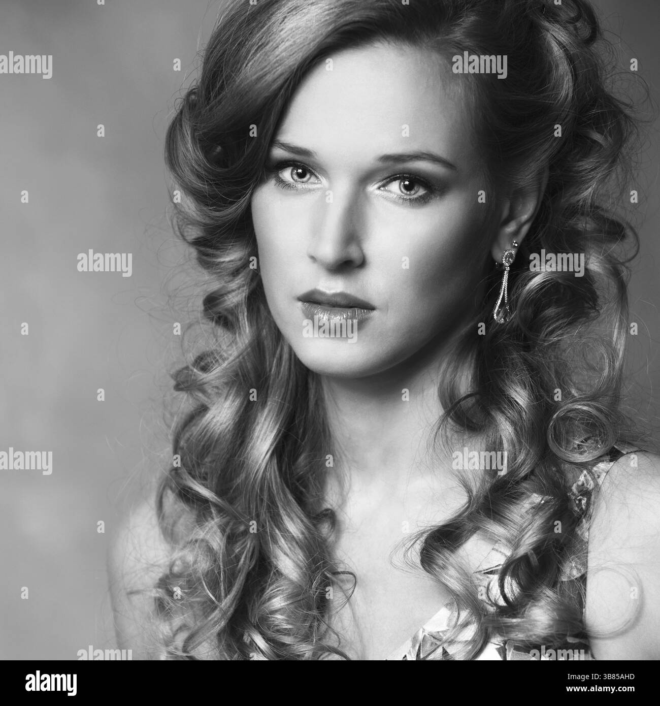 Beautiful model with long curly hair and professional make-up. Fashion ...