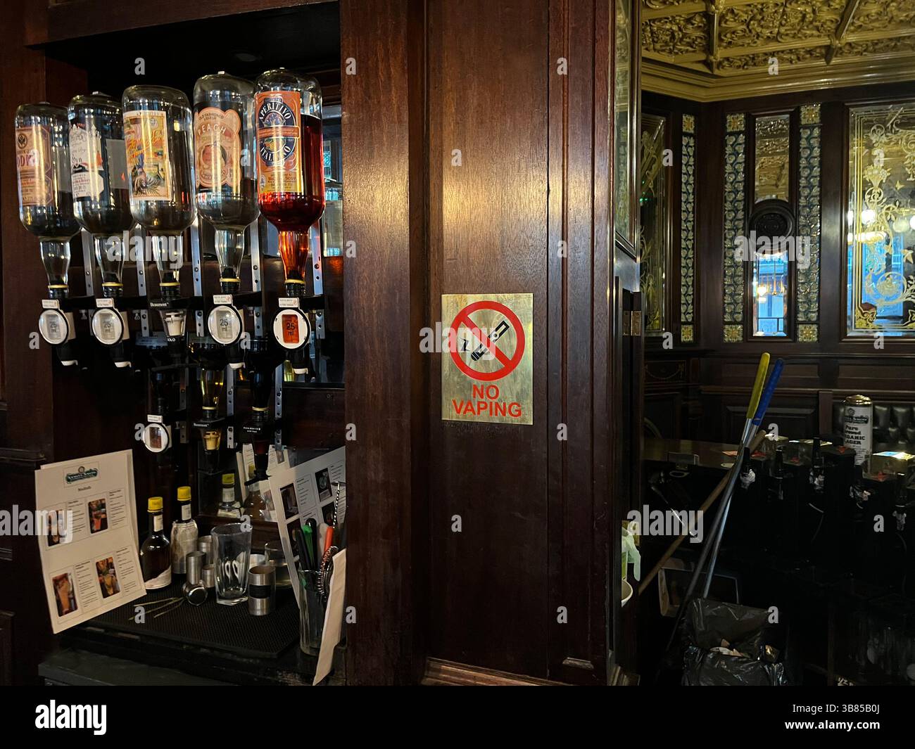 A No Vaping sign with drink optics in a The Fitzroy Tavern and pub a ...