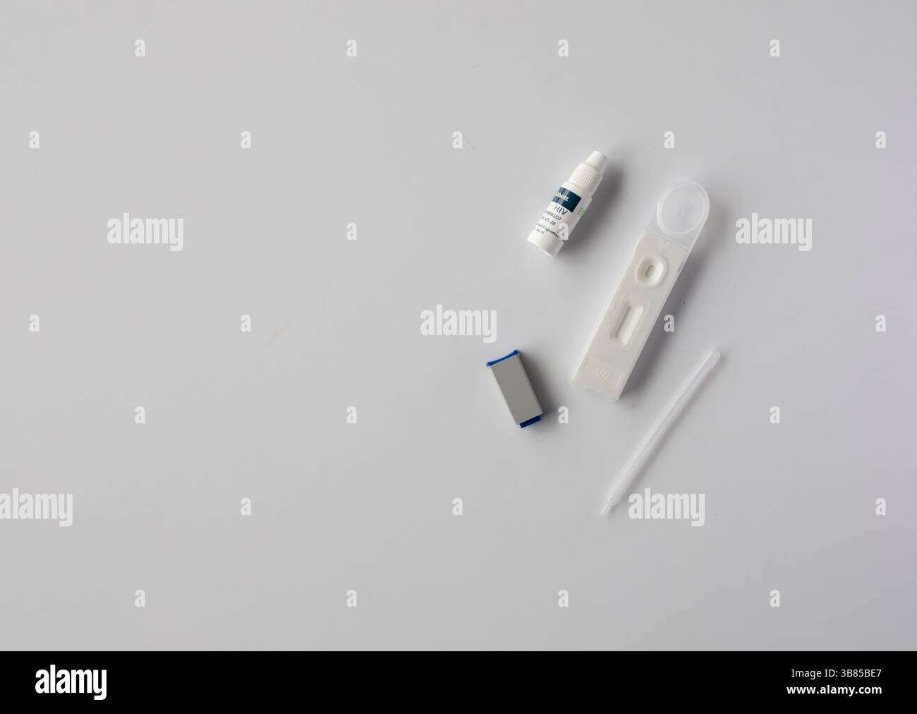 Flat lay of an HIV rapid test kit including dropper, test cassette ...