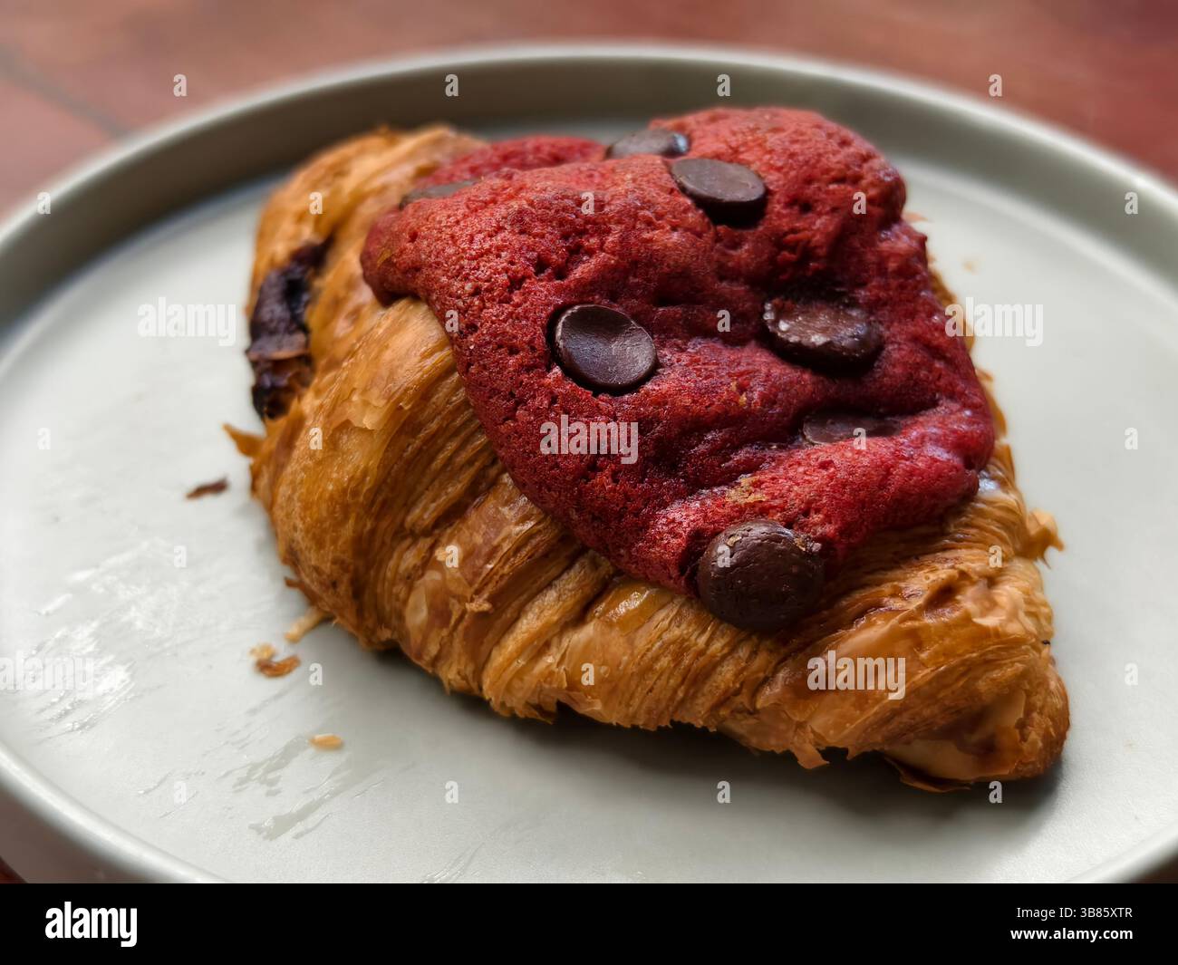 A flaky croissant filled with peanut butter, topped with a red velvet ...
