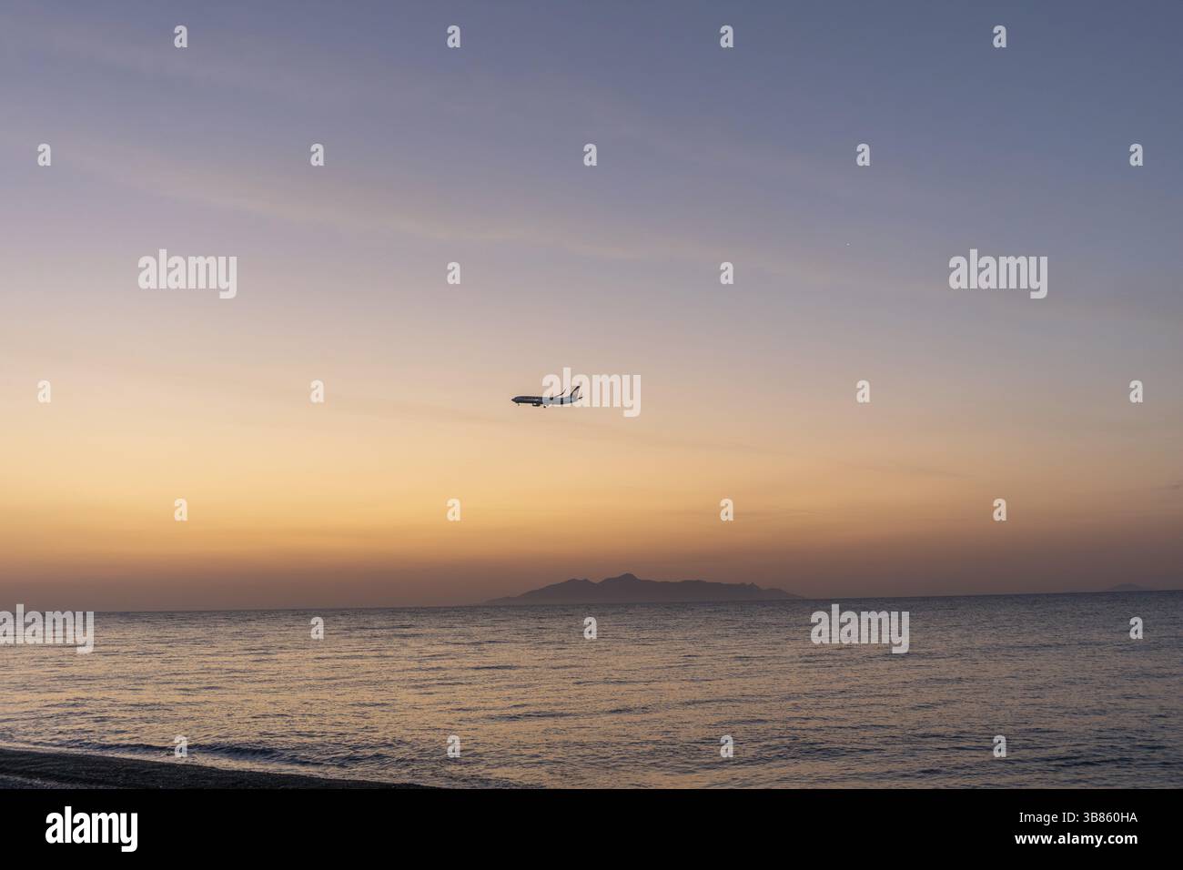 Dawn at sunrise, aeroplane approaching Kamari, view from the lava beach ...