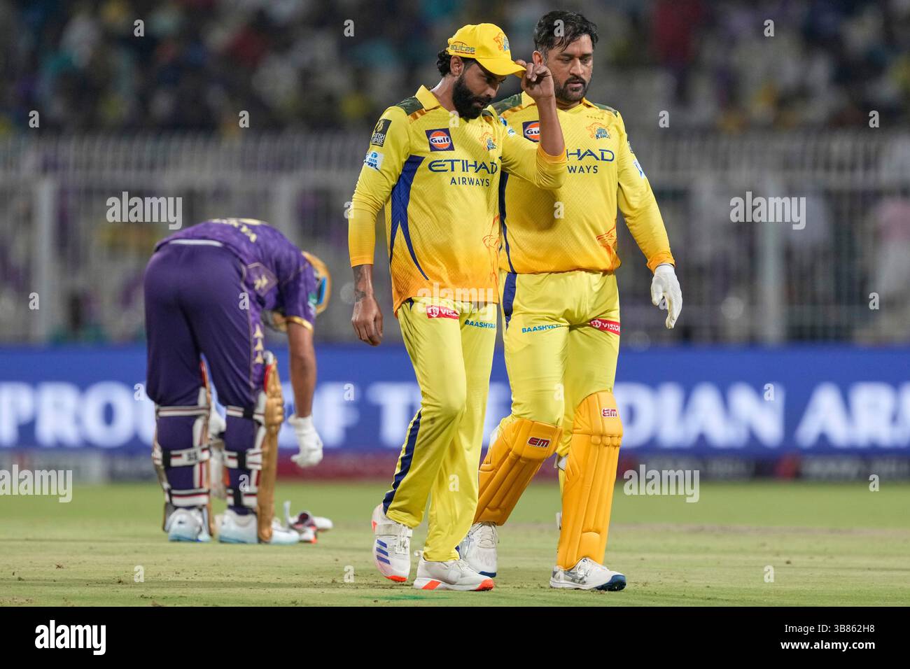 Chennai Super Kings' Ravindra Jadeja, left, listens to captain Mahendra Singh Dhoni as he walks ...