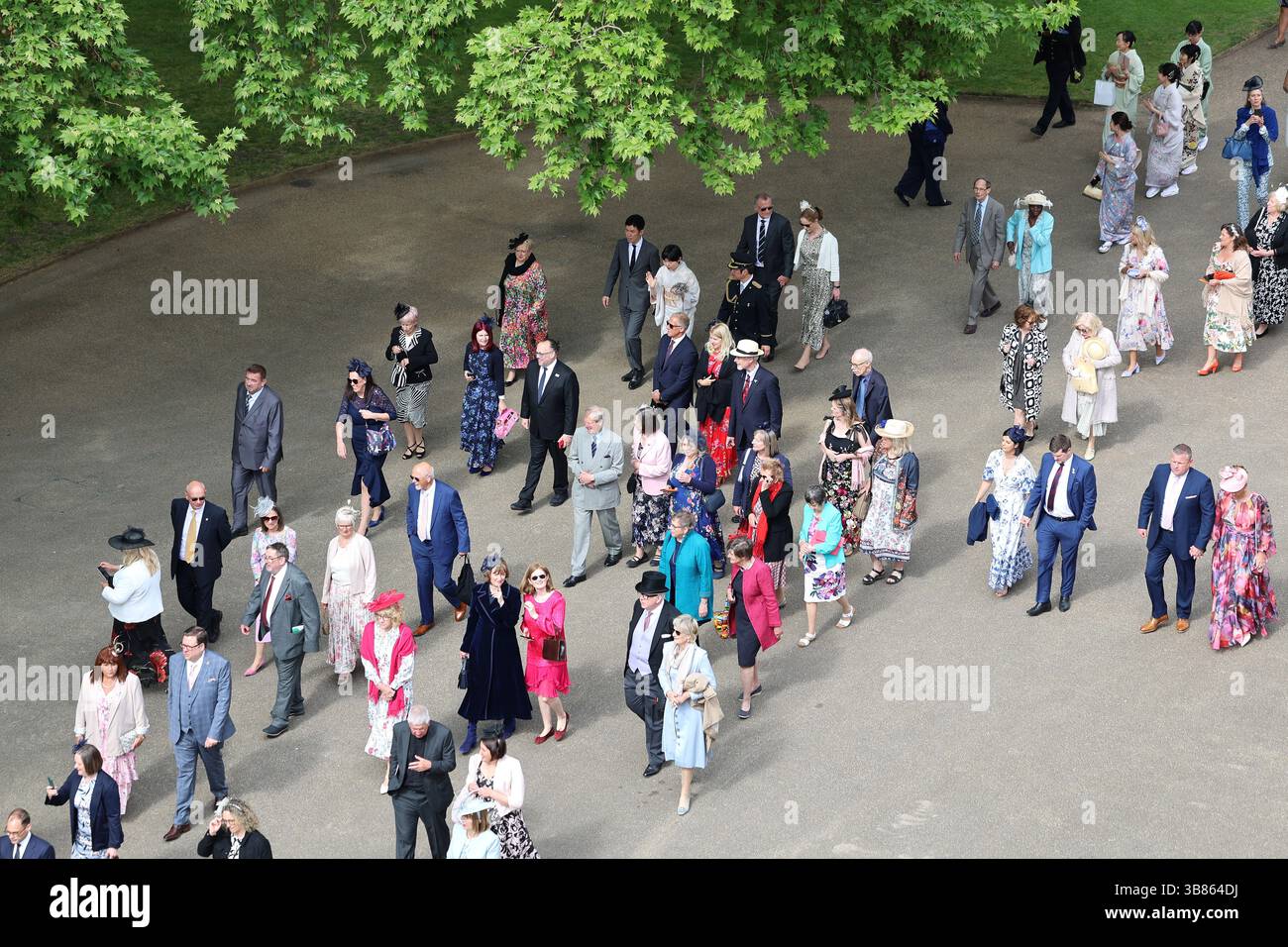 Guests attend a Royal Garden Party at Buckingham Palace, London ...