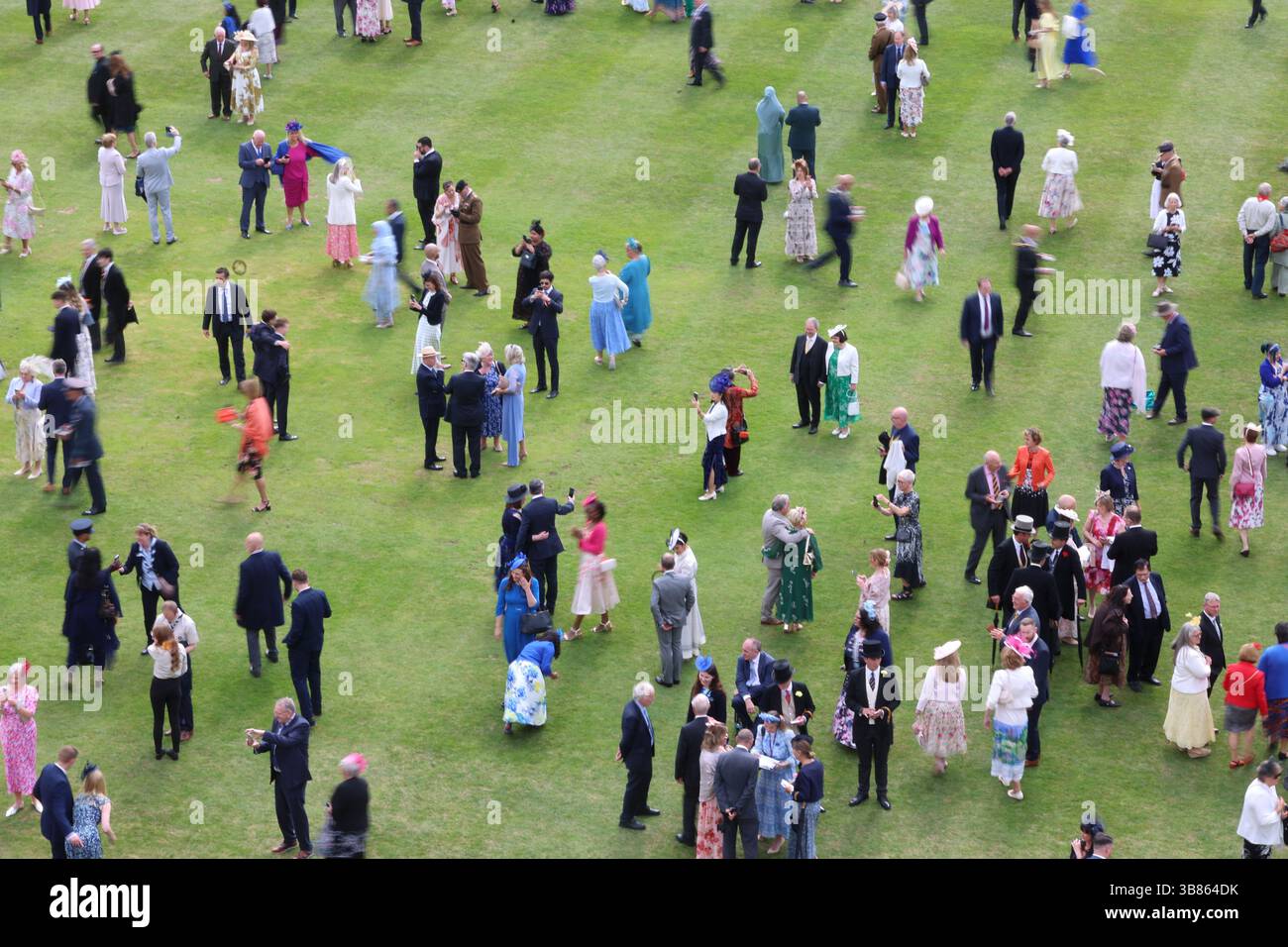 Guests attend a Royal Garden Party at Buckingham Palace, London ...
