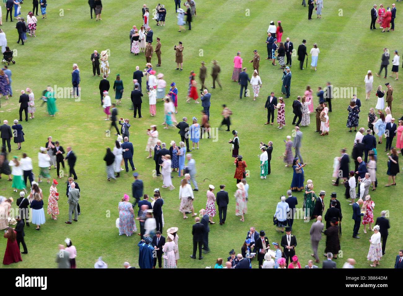 Guests attend a Royal Garden Party at Buckingham Palace, London ...