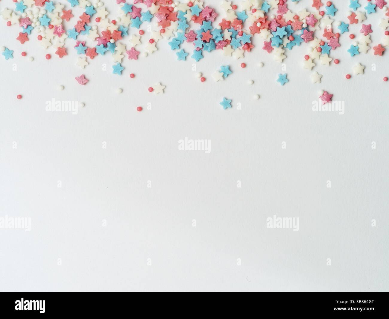 Festive border frame of colorful pastel sprinkles on white background ...