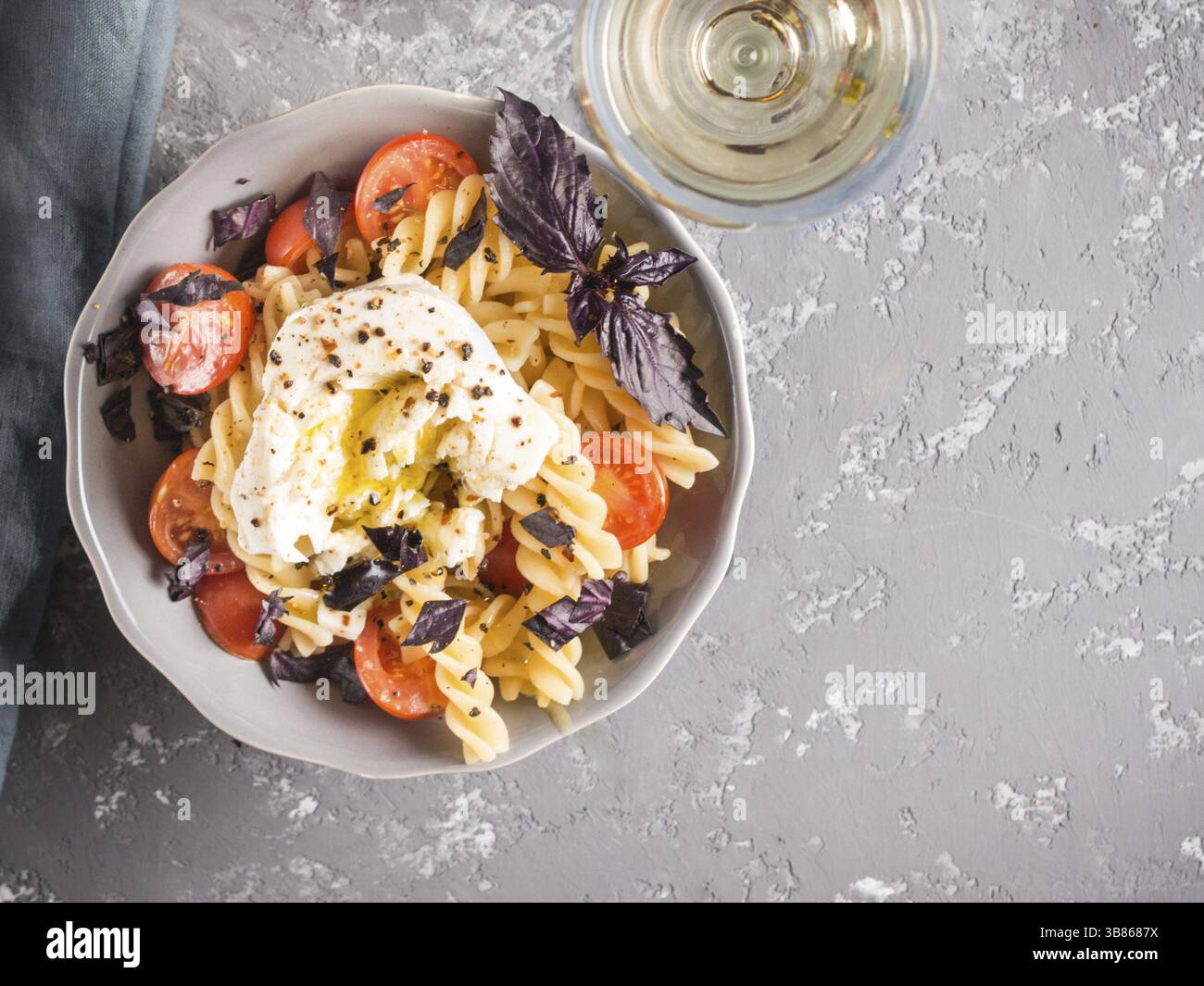 Tasty italian fusilli pasta with cherry, mozarella or buratta cheese ...