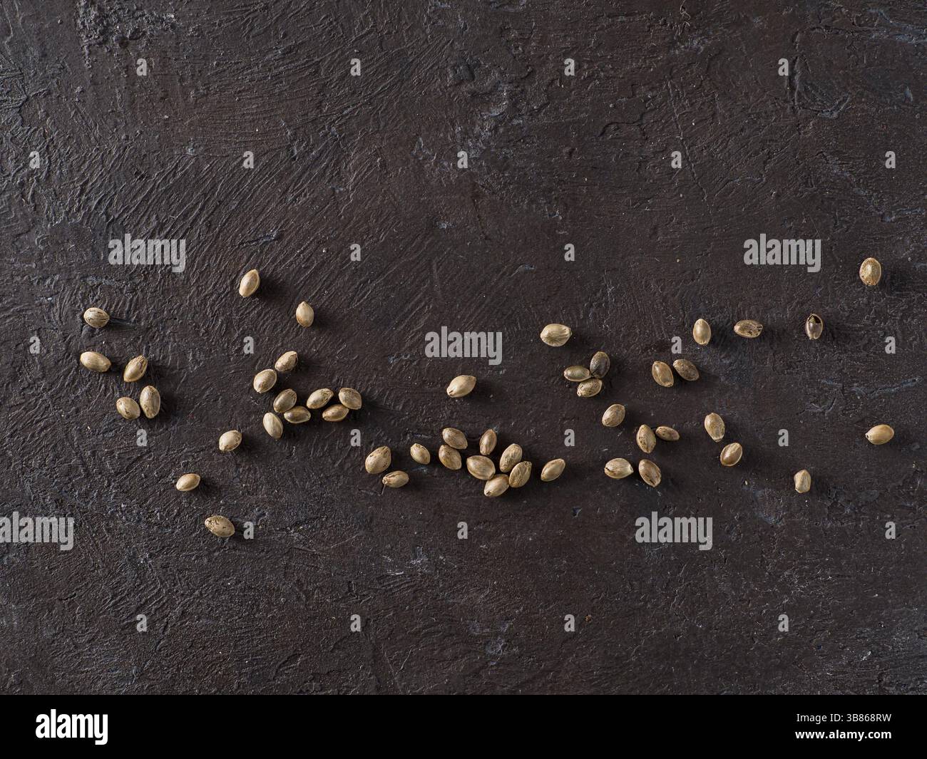 Hemp seeds top view. Unpeeled raw organic hemp seed on black background ...