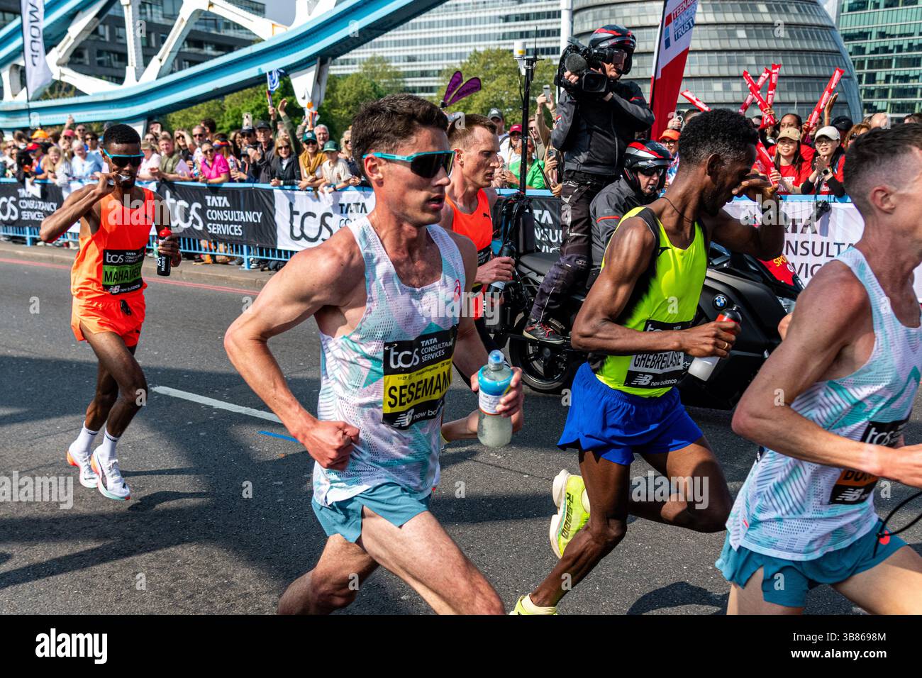 A cameraman filming British elite runners Sesemann and Ghebresilasie ...