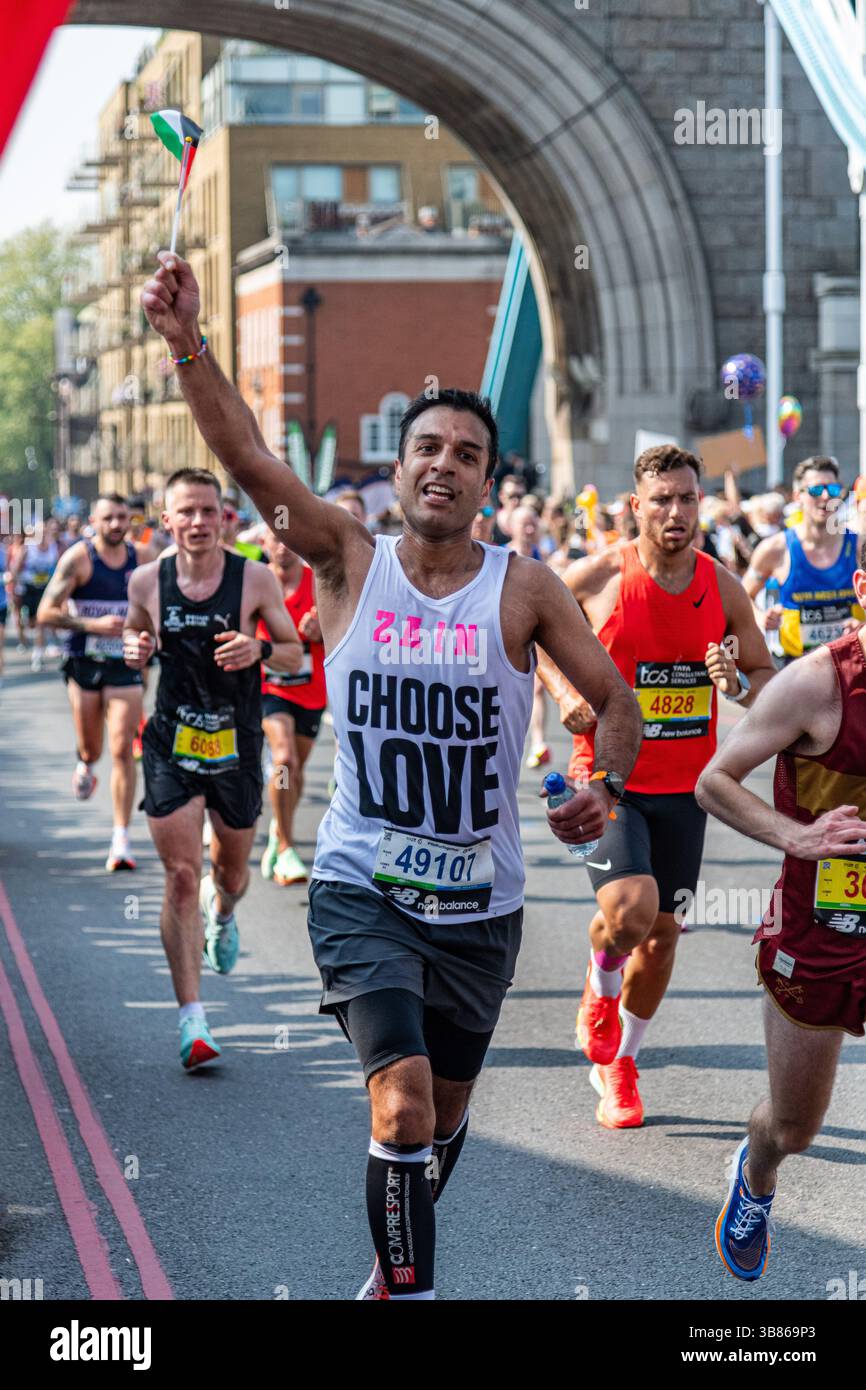 Runners running at the London Marathon 2025 on Tower Bridge in Central ...